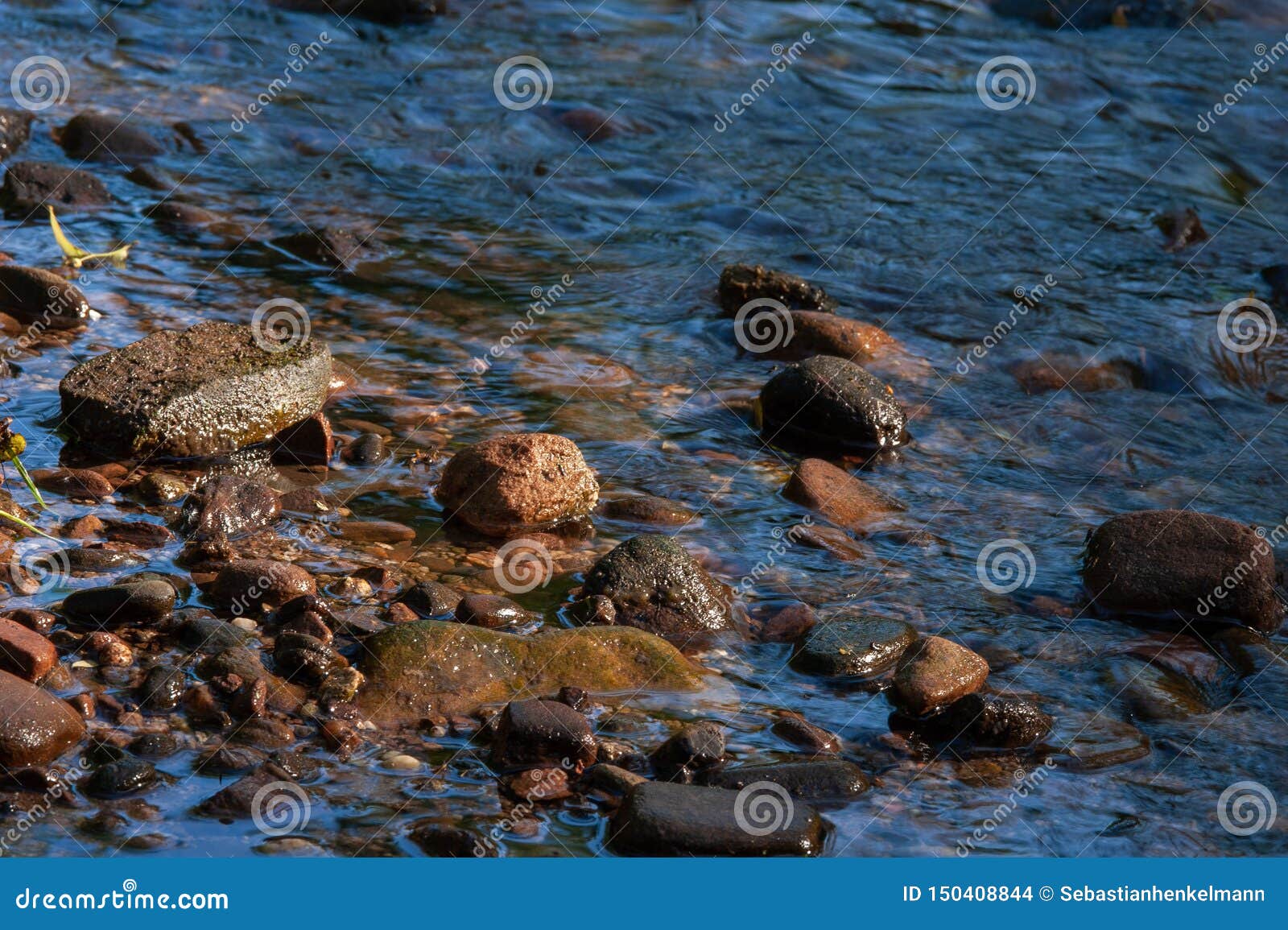 Rocks in shallow water stock photo. Image of beauty - 150408844