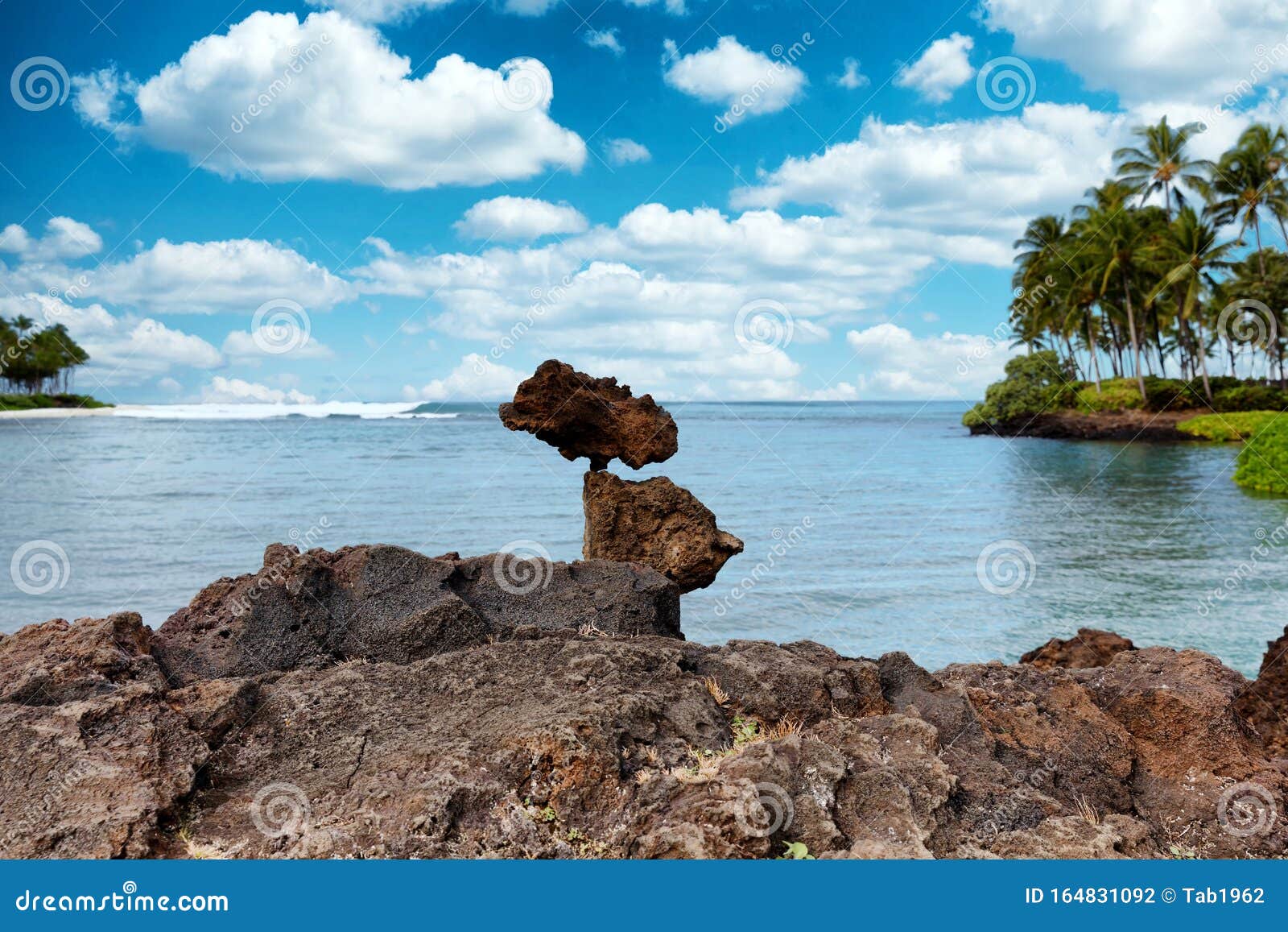 Rocks Stacked Vertically with Ocean Waves in Background Stock Photo ...
