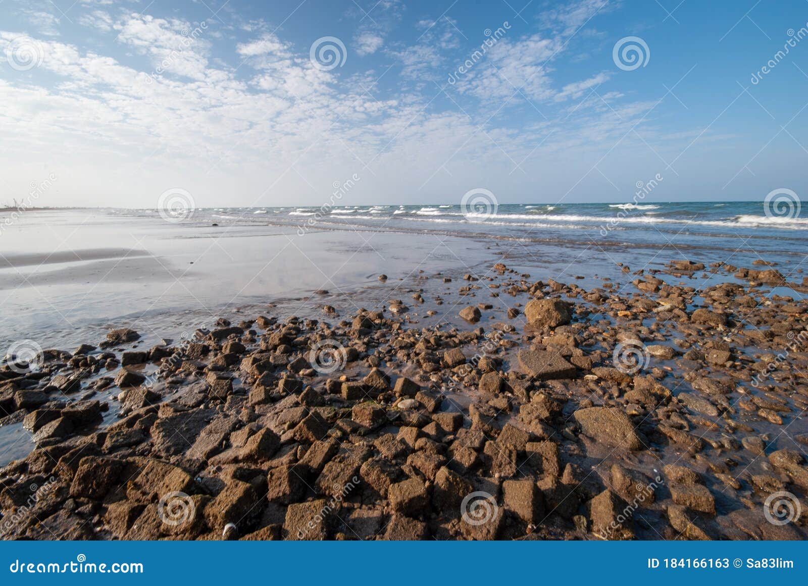 Rocky beach Muscat stock image. Image of cloudy, landscape - 184166163