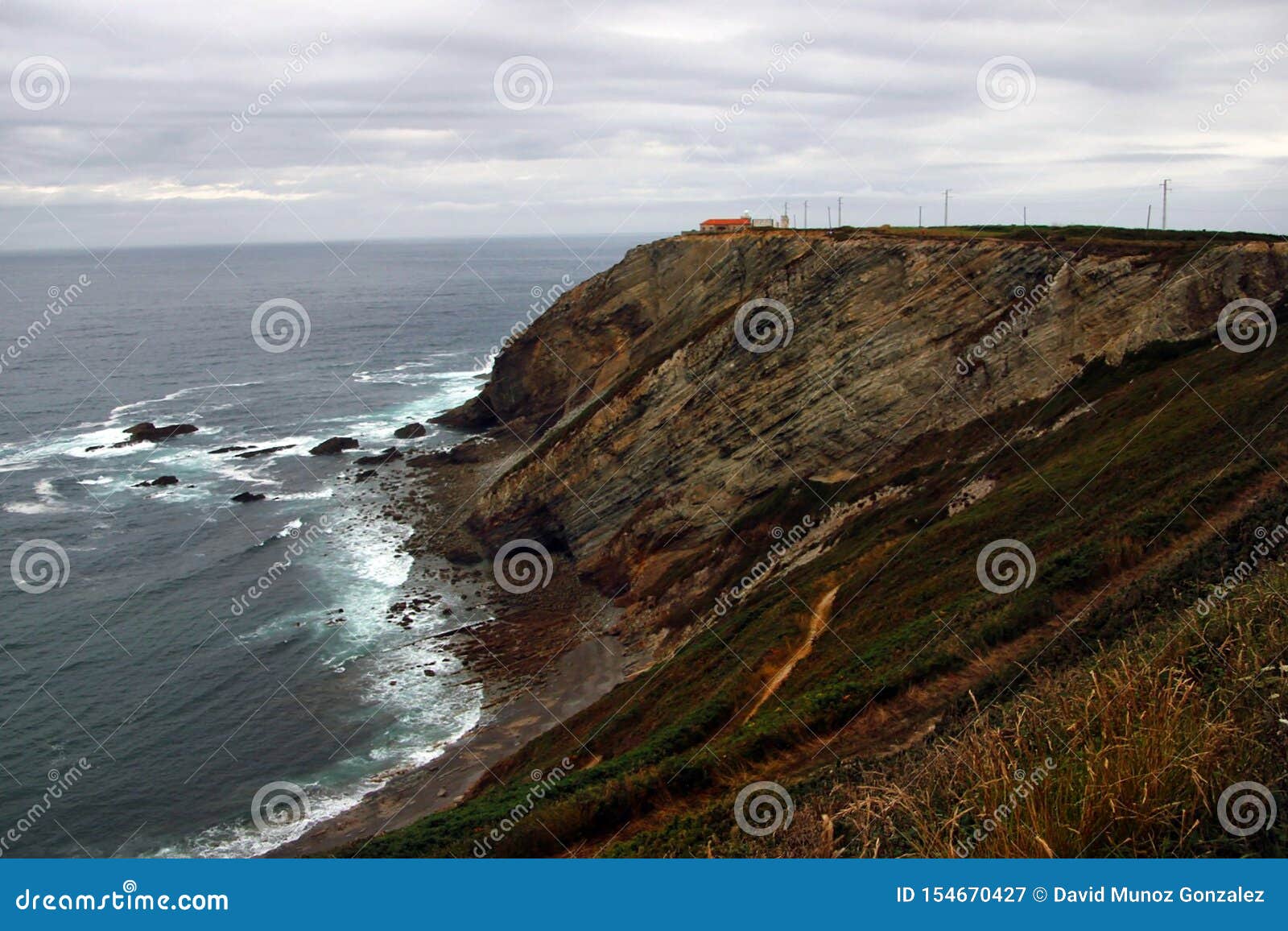 Rocky cliff next to a sea. stock image. Image of rock - 154670427