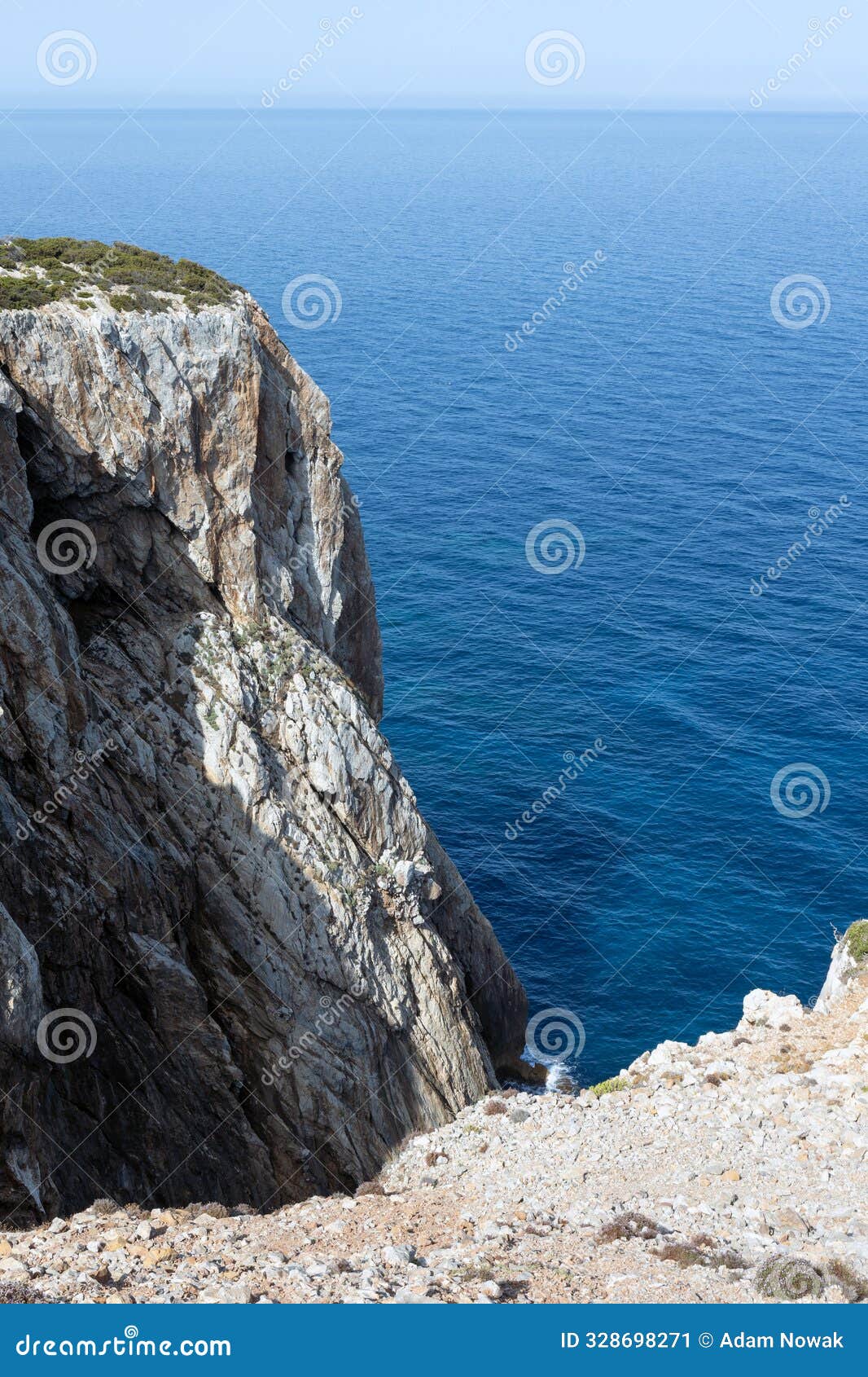 Rocky Cliffside Overlooking Deep Blue Sea Stock Image - Image of ...