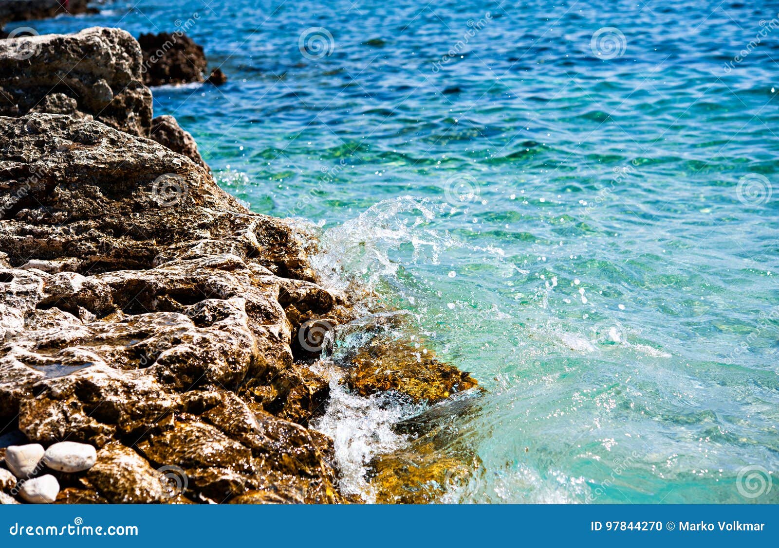 Rocky Coast with Splash Water in Front of Blue Sea Stock Photo - Image ...