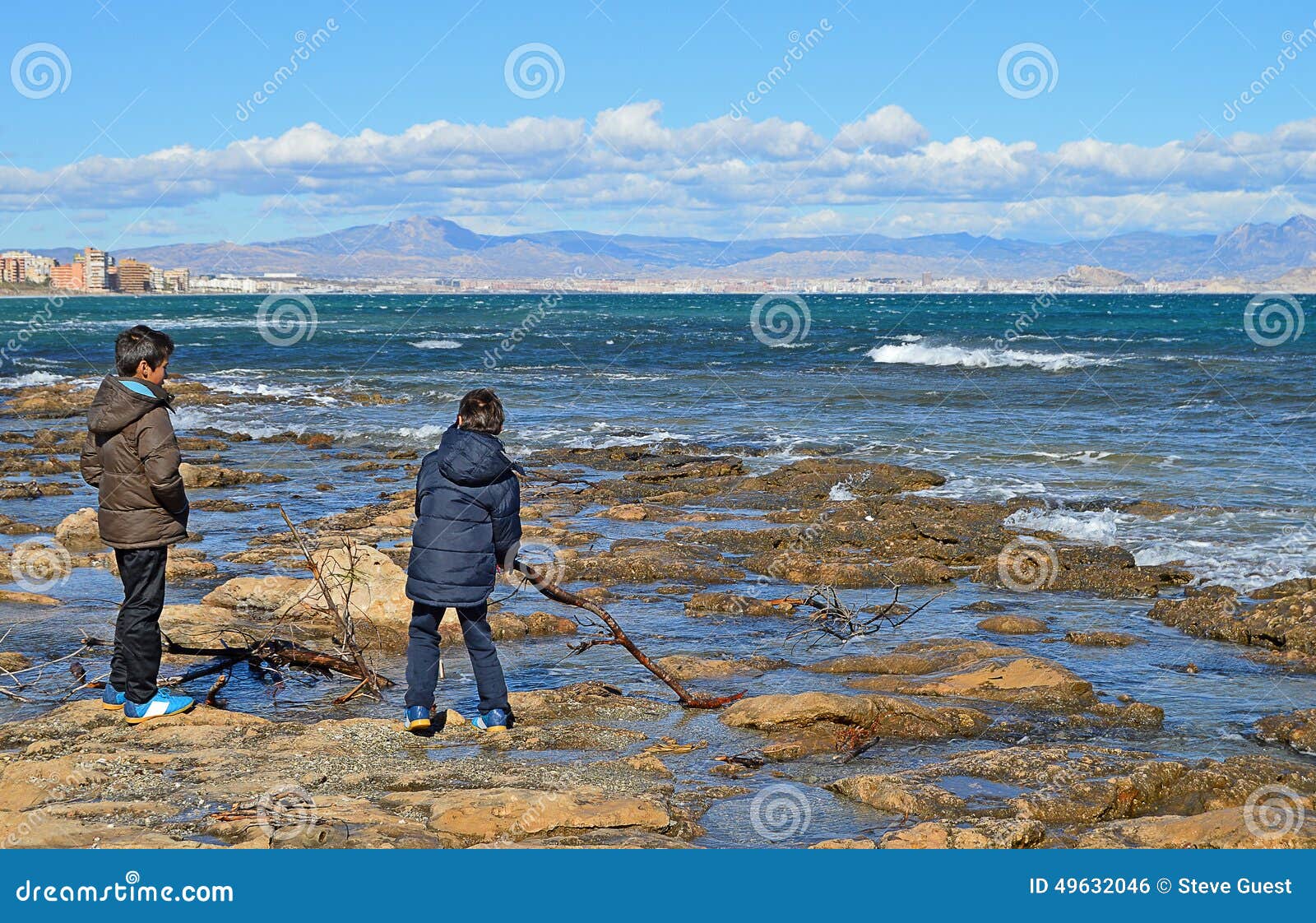 Rocky Coast, Two Boys Playing on the Rugged Beach Stock Photo - Image ...