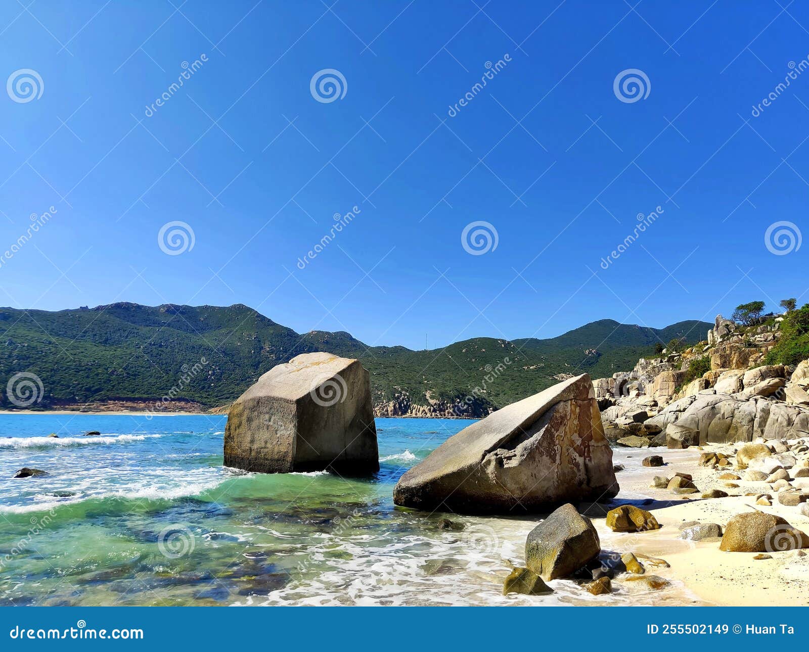 A Rocky Sandy Beach with Large Massive Big Rock Boulder in the Water ...