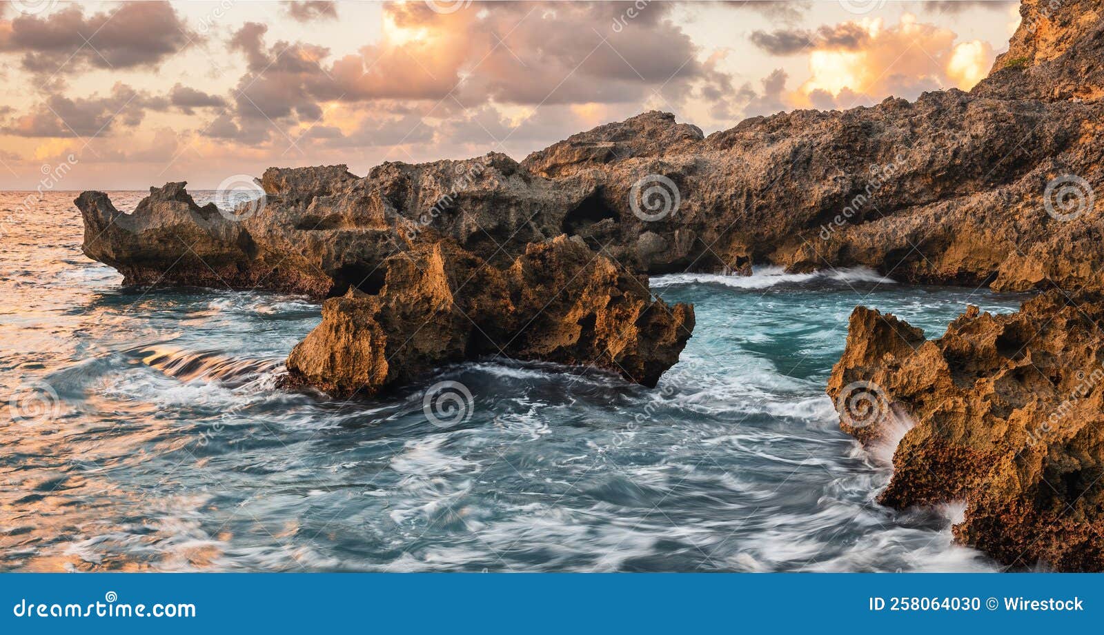 Rocky sea coast at sunset stock photo. Image of coast - 258064030