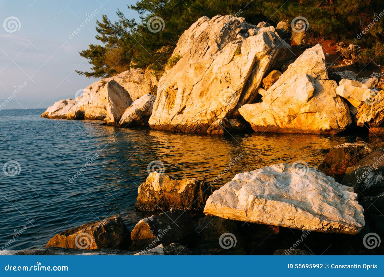 Rocky sea shore stock photo. Image of rocks, sunset, lighted - 55695992