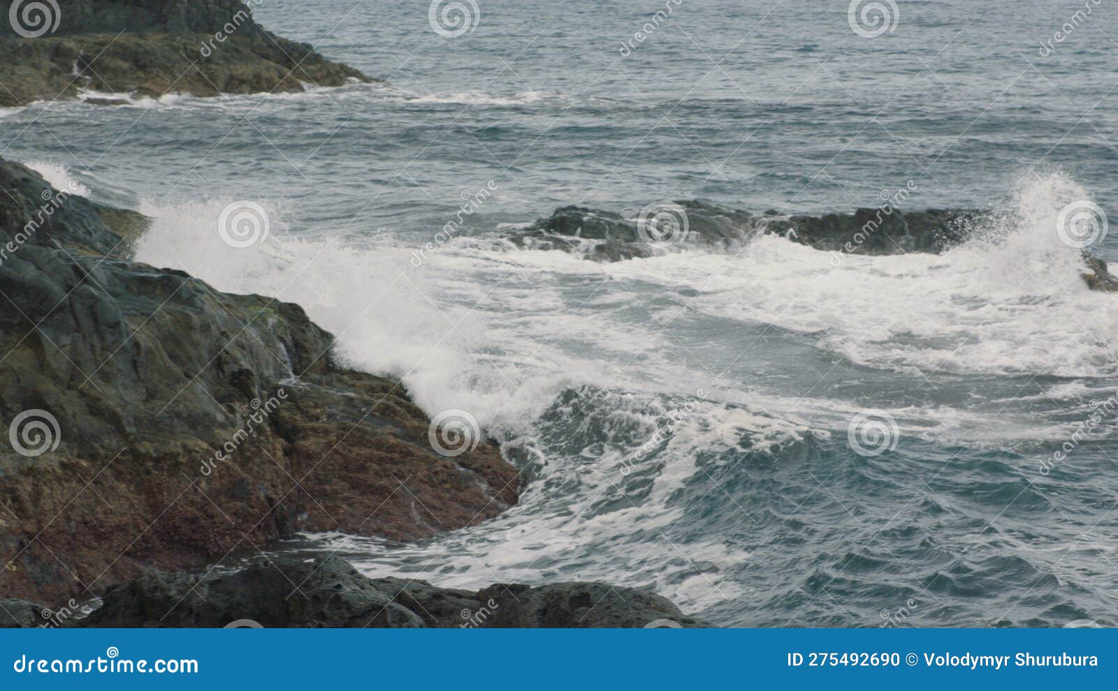 A Rocky Shore in the Ocean with Stormy and Foamy Waves Crashing Against ...