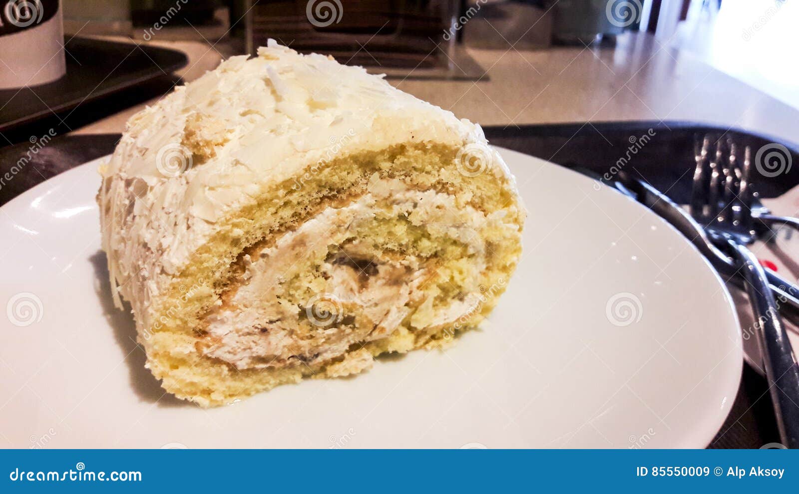 Roll Cake in White Plate with Fork and Knife at Cafe Stock Image ...
