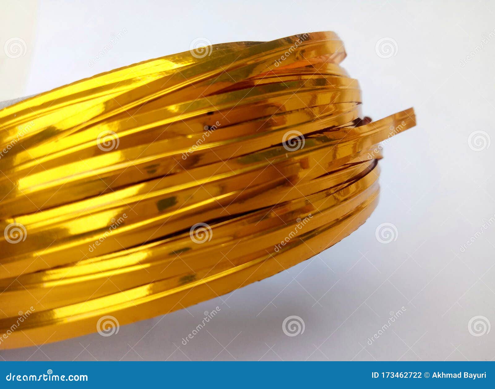Roll of Flat Gold Wire Rope with a White Background Stock Photo - Image ...