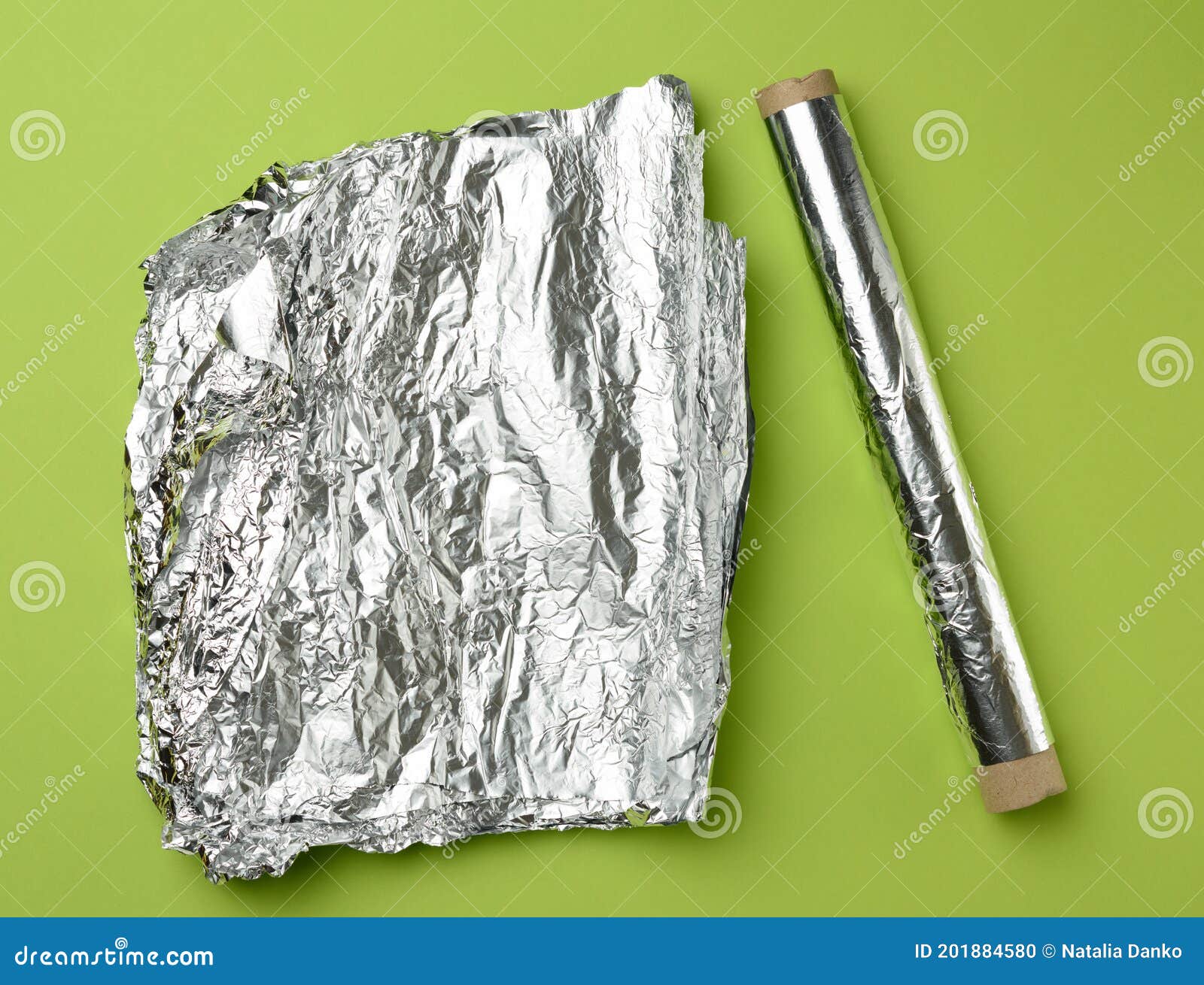 Roll of Gray Foil for Baking and Packaging Food on a Green Background ...
