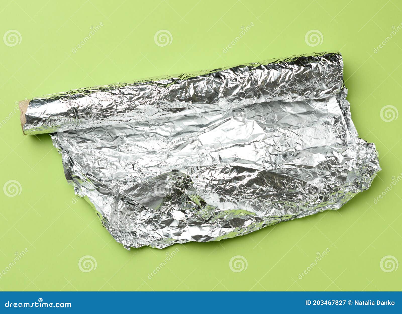 Roll of Gray Foil for Baking and Packaging Food on a Green Background ...