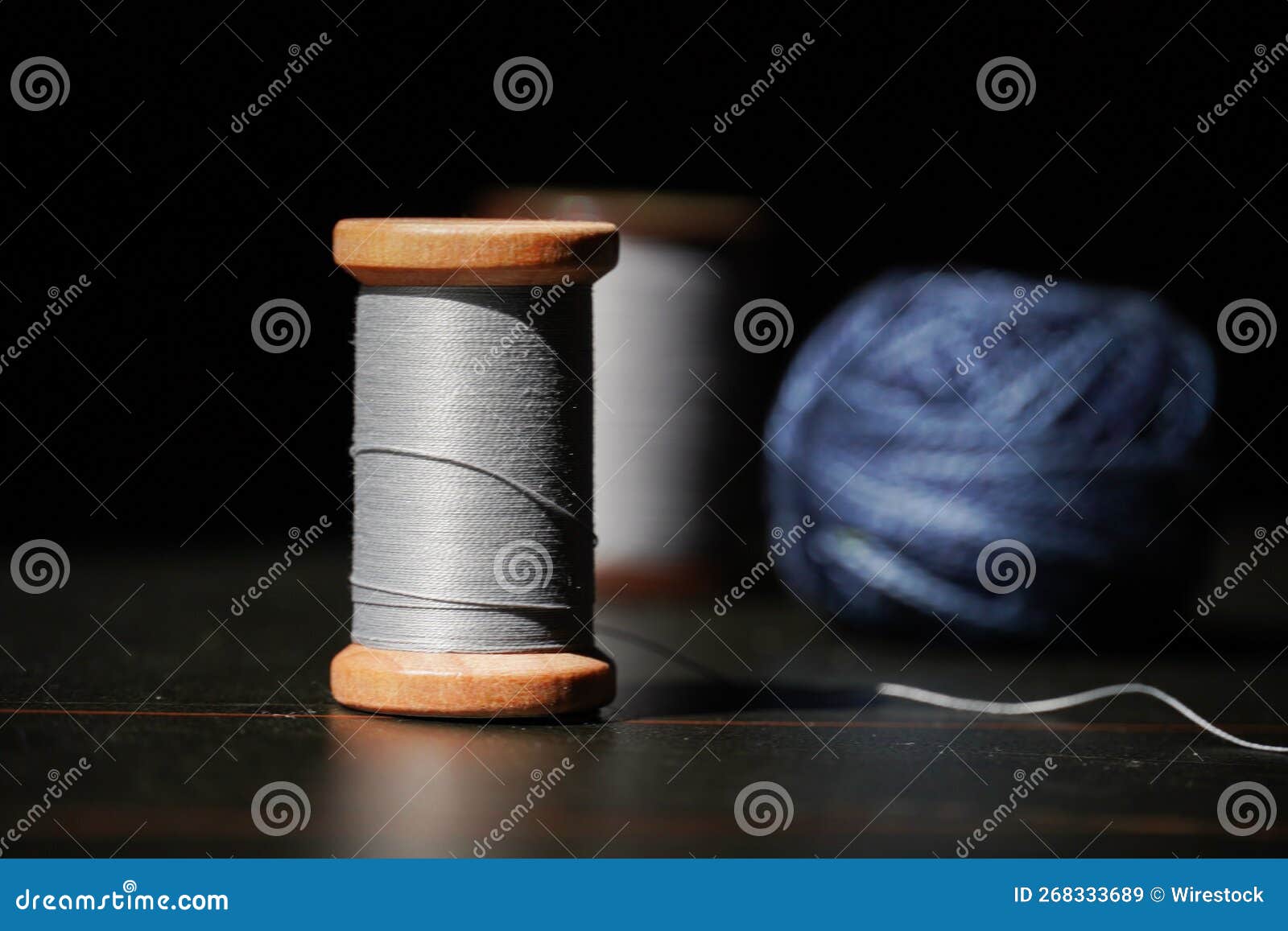 Roll of Gray String with Sunlight on it Against Black Background Stock ...
