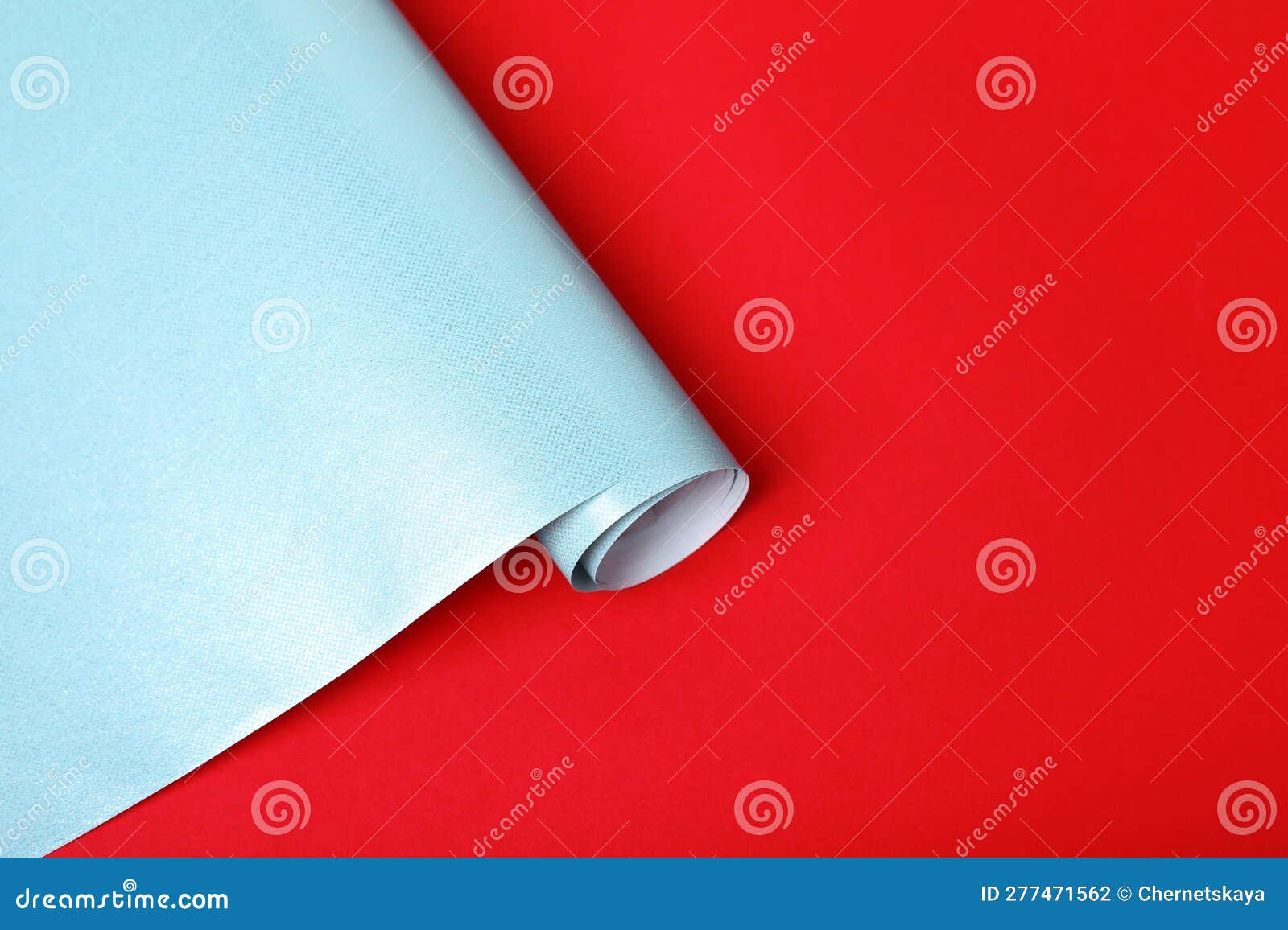 Roll of Light Blue Wrapping Paper on Red Background, Closeup. Space for ...