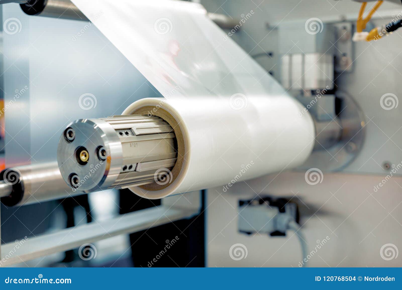 Roll of Packaging Film. Feeding Unit of a Modern Packaging Machine ...