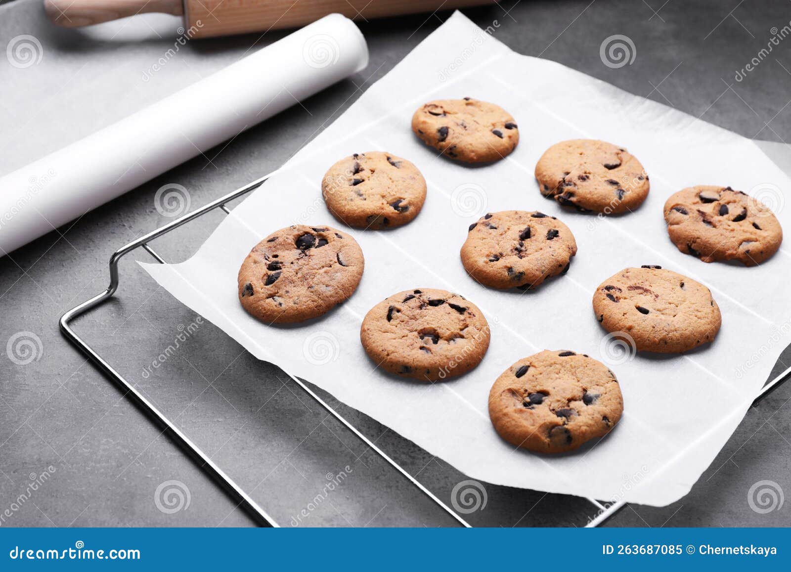 Roll of Parchment Baking Paper and Cooling Rack with Tasty Cookies on ...