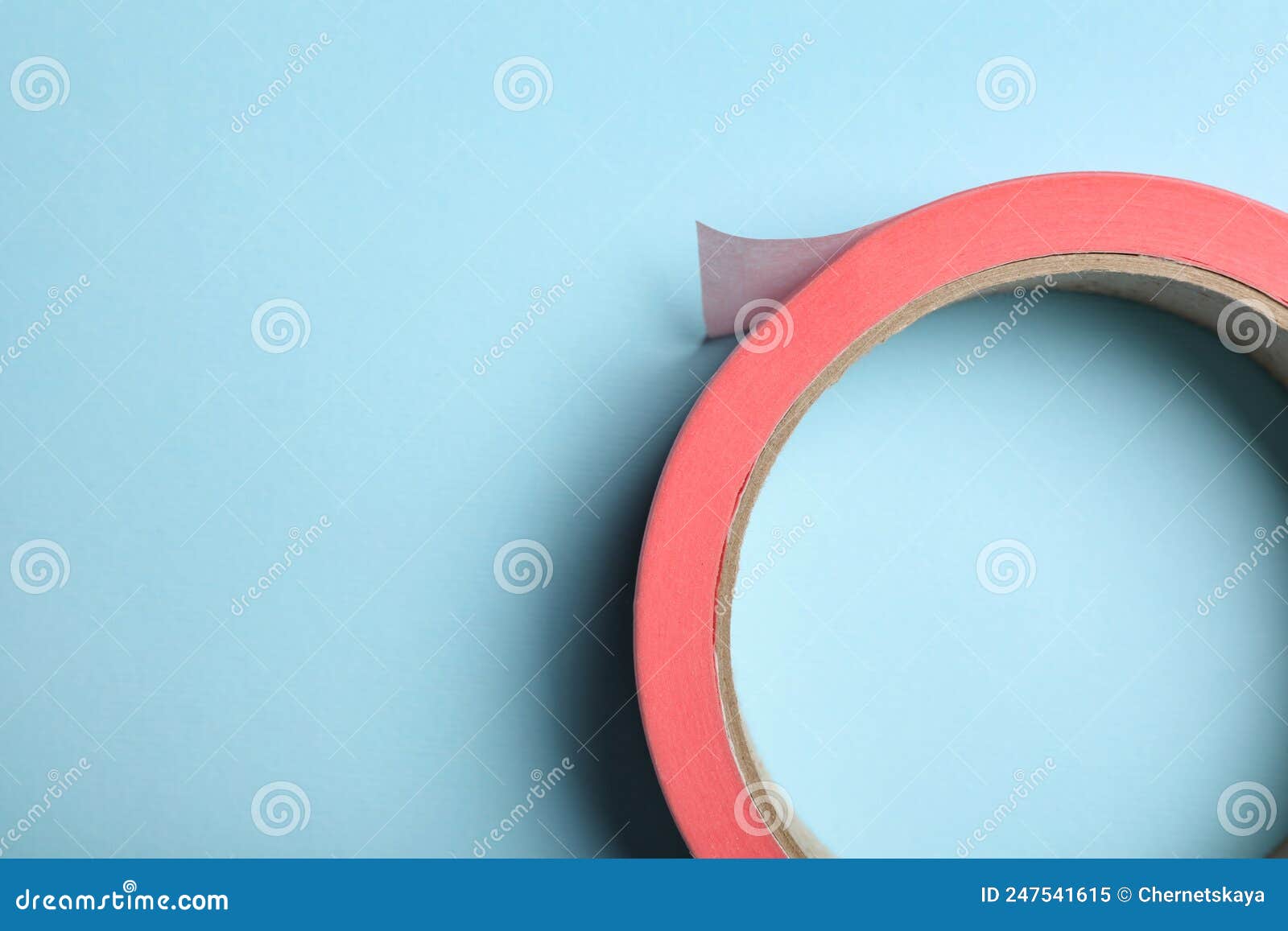 Roll of Pink Adhesive Tape on Light Blue Background, Top View. Space ...