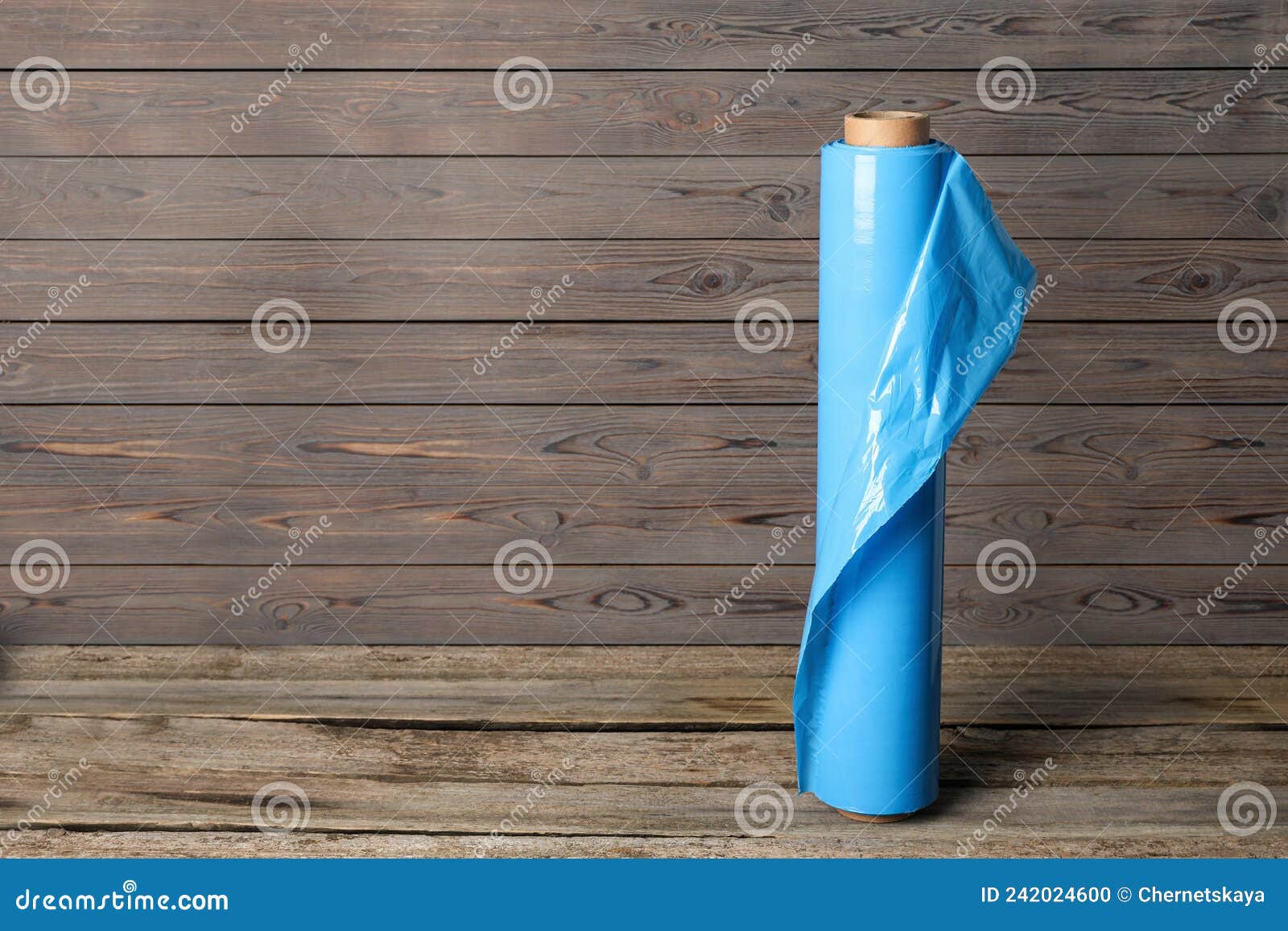 Roll of Plastic Stretch Wrap Film on Wooden Table, Space for Text Stock ...
