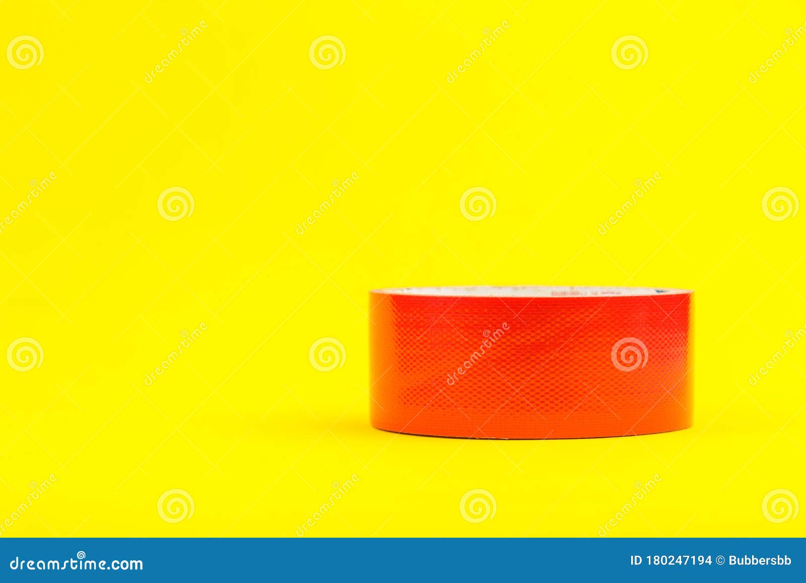 A Roll of Red Duct Tape Isolated on a Yellow Background Stock Photo ...