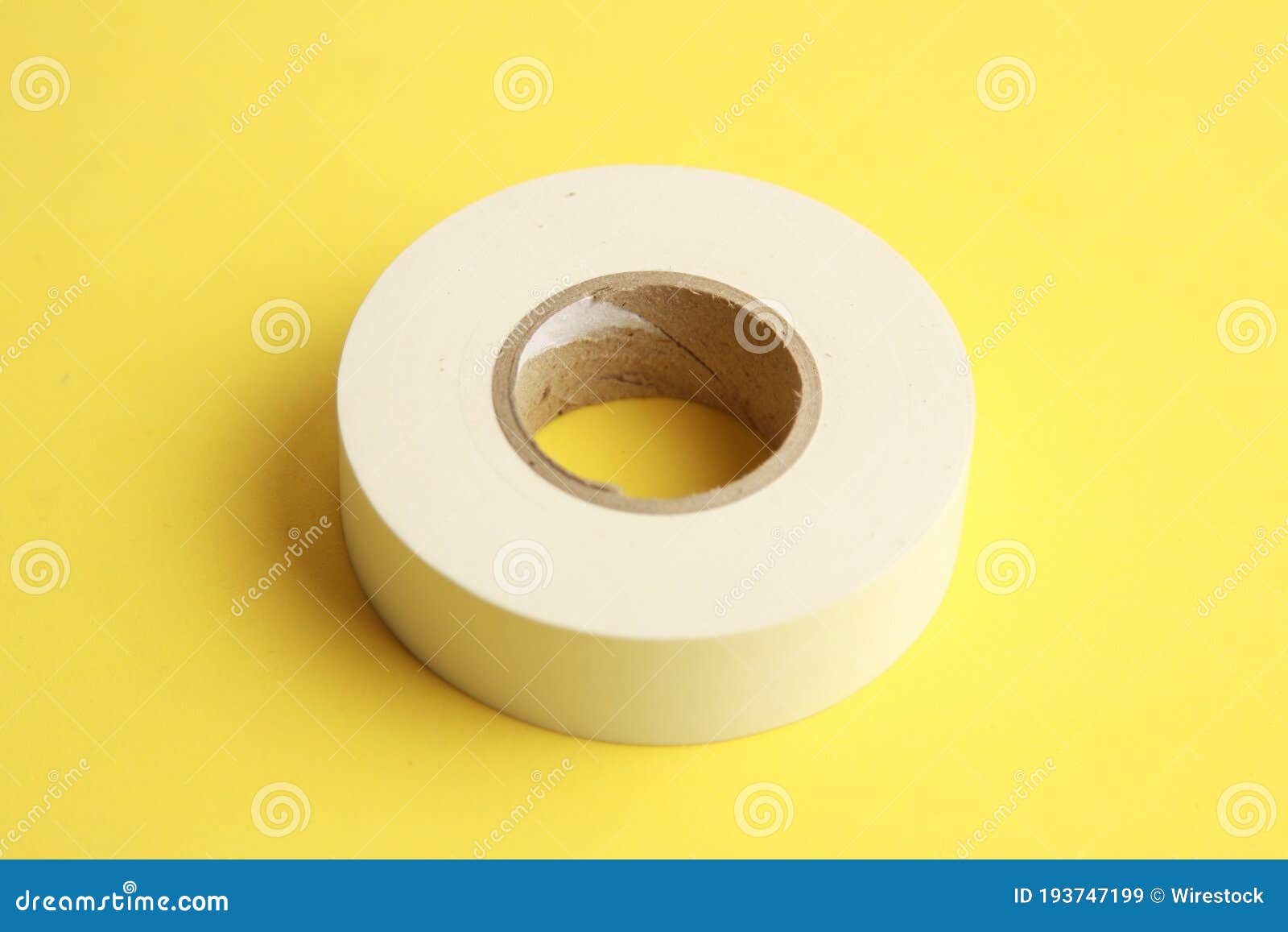 Roll of White Tape Isolated on a Yellow Background Stock Image - Image ...