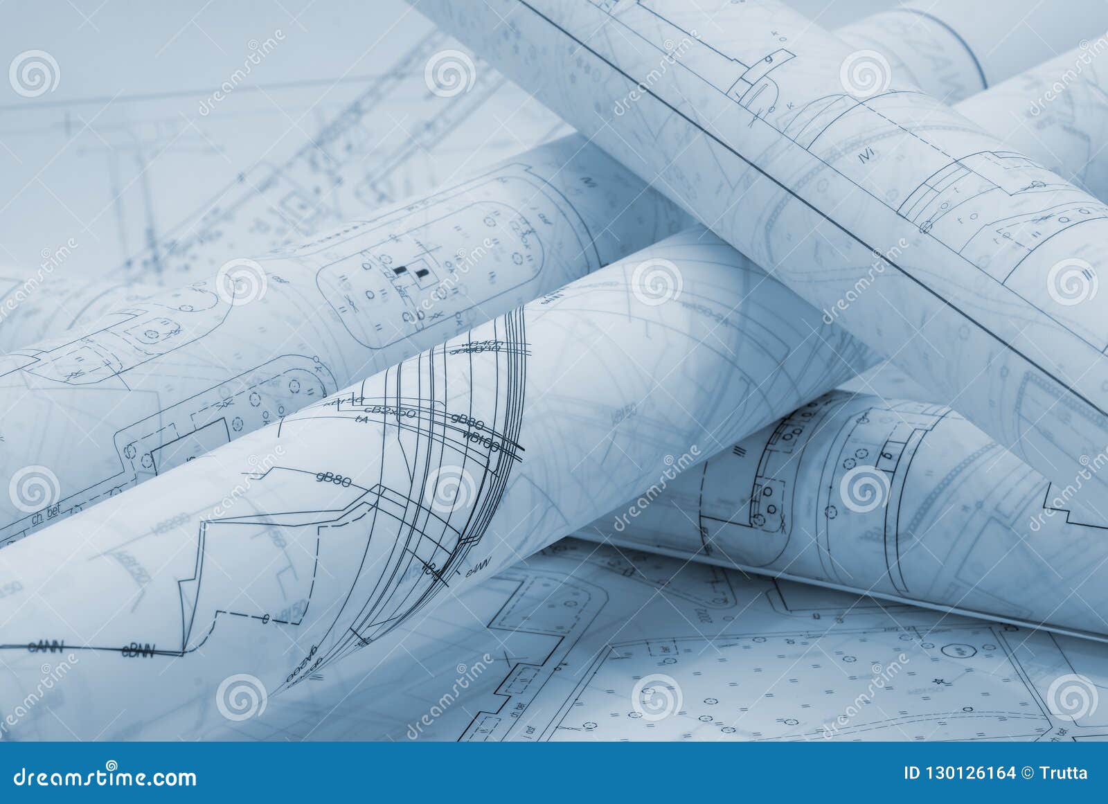 Rolled Architectural Blueprints And Technical Drawings On Desk Royalty ...