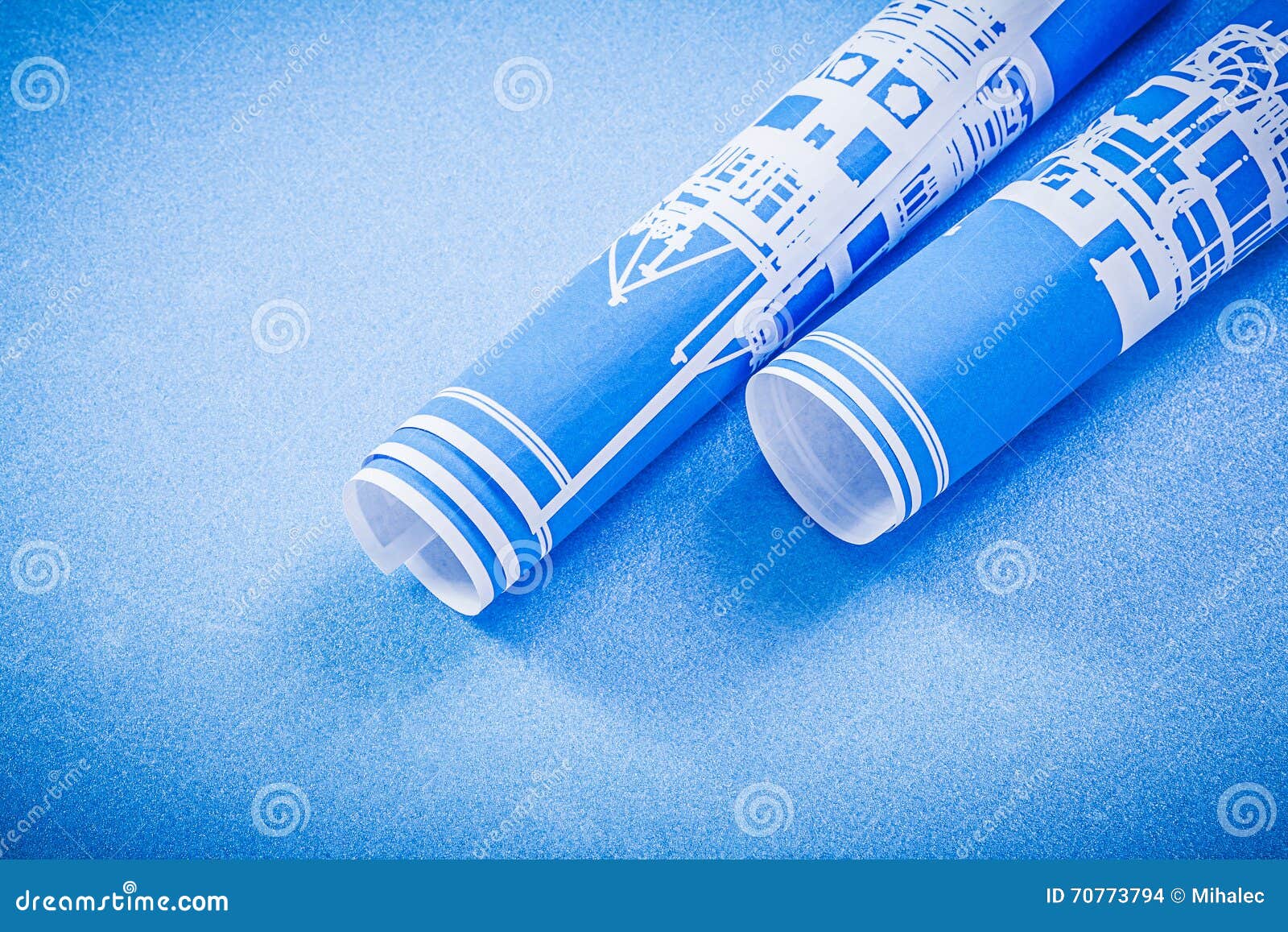 Rolled Blueprints on Blue Background Construction Concept Stock Photo ...
