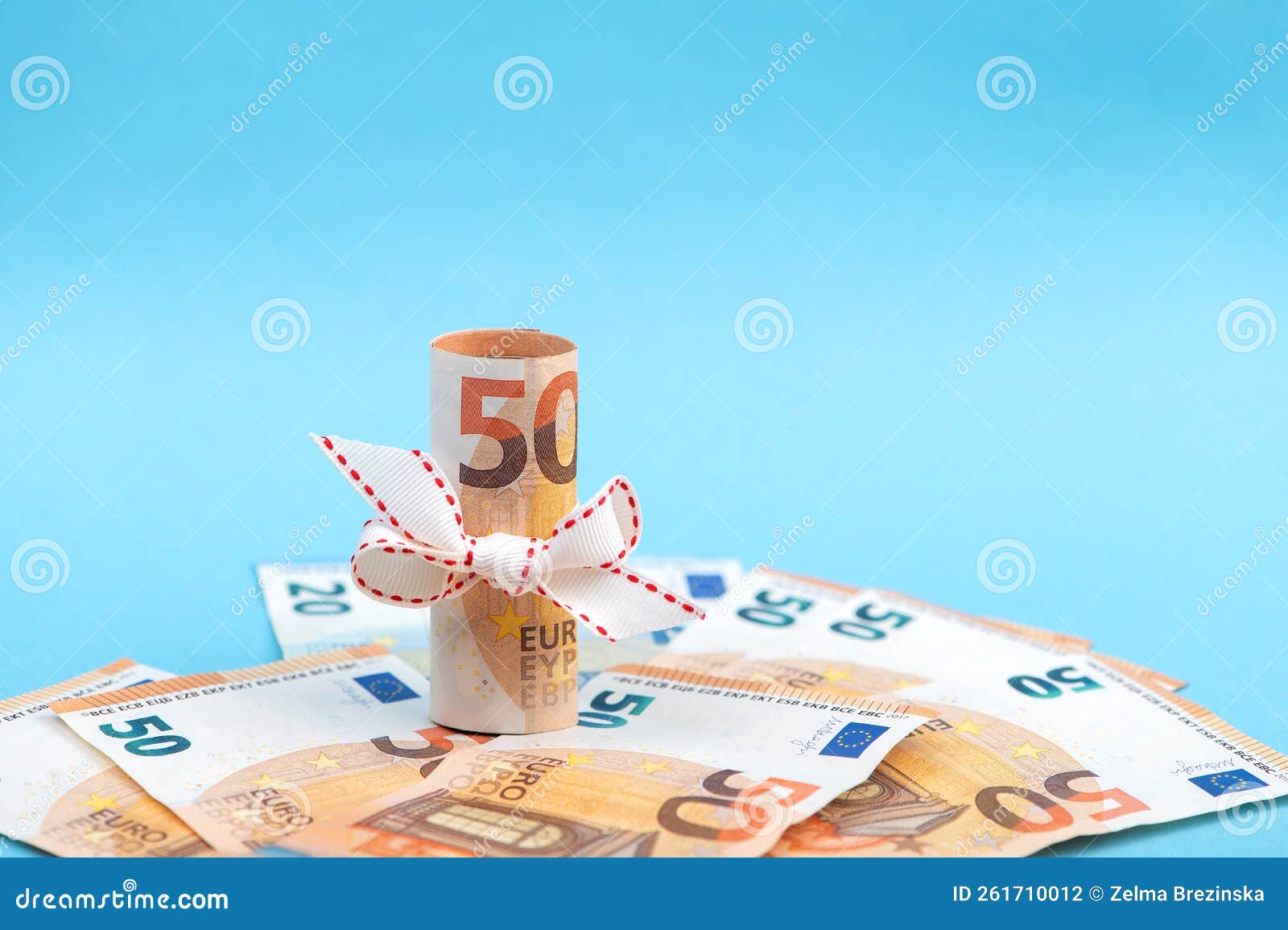 Rolled into a Roll of 50 Euros on a Light Blue Background of 20 Euro ...