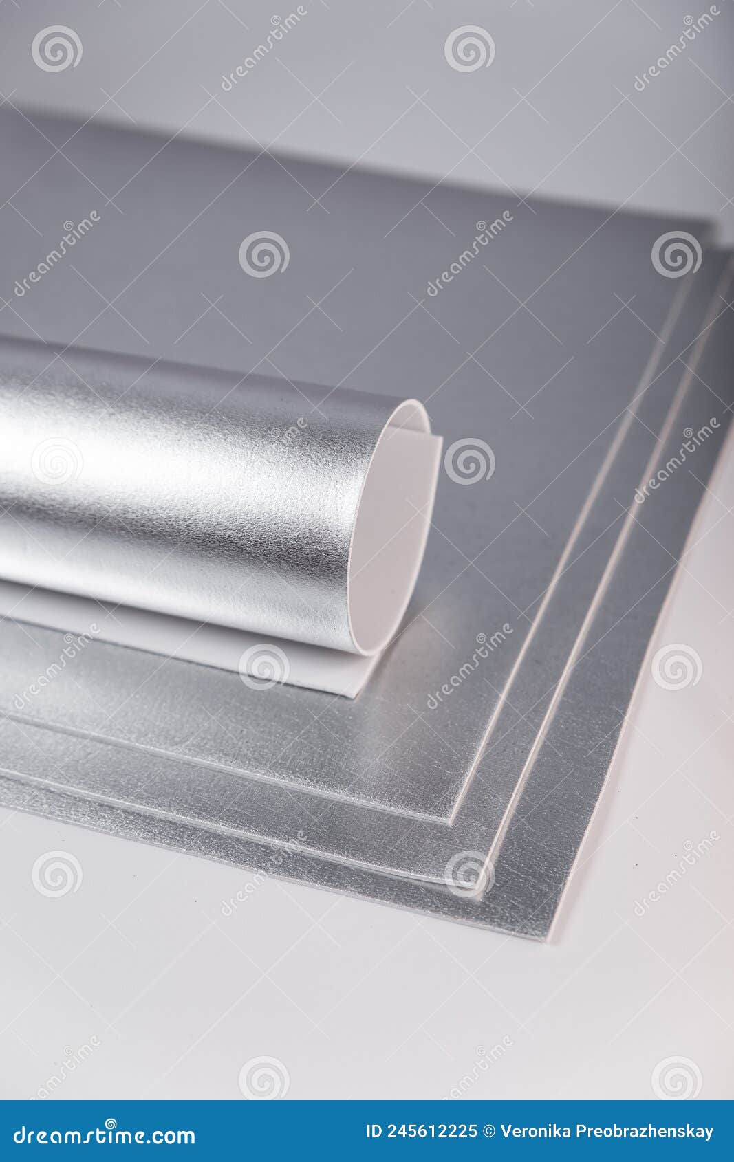 Rolled Silver Sheet of Cardboard. Sheets of Shiny Isolon. Metallic ...