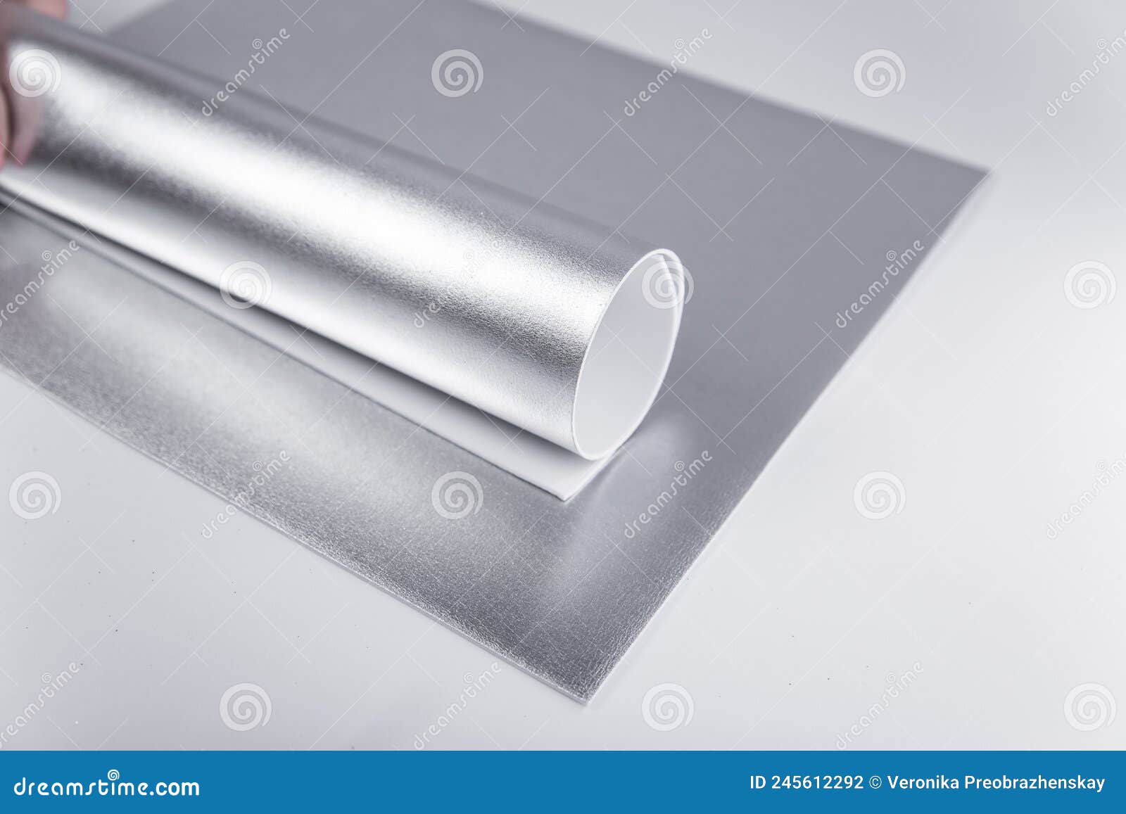 Rolled Silver Sheet of Cardboard. Sheets of Shiny Isolon. Metallic ...