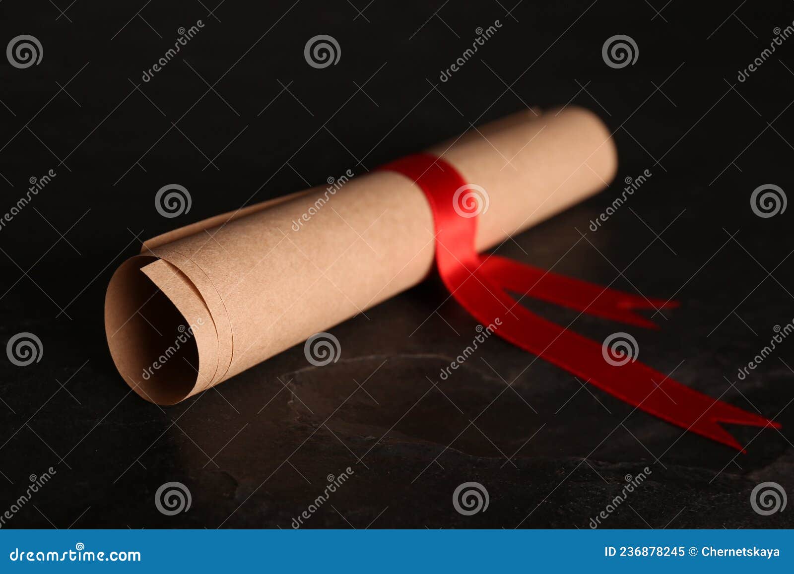 Rolled Student`s Diploma with Red Ribbon on Black Table Stock Image ...