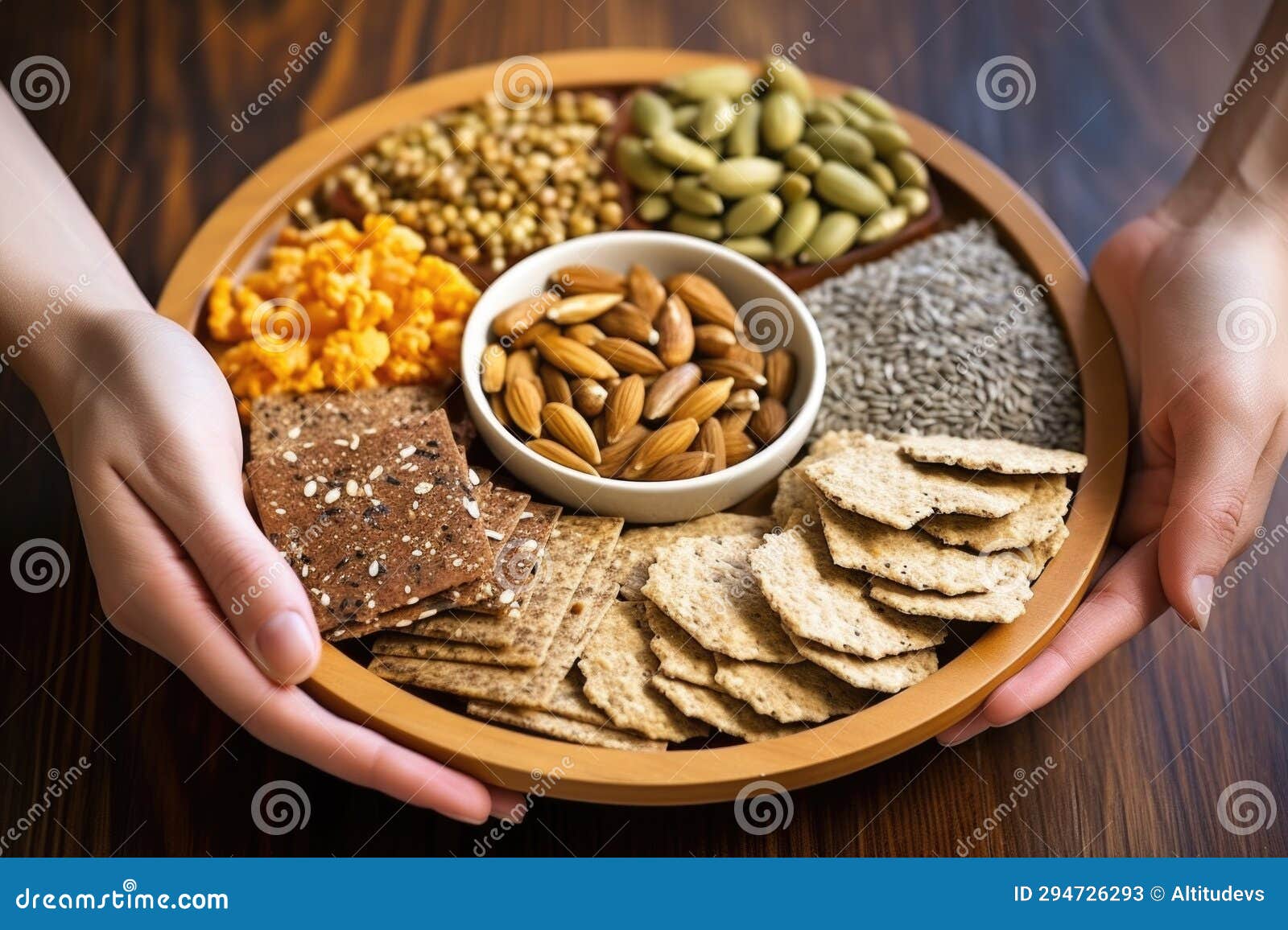Rolled Up Sleeve Hand Presenting Plate of Various Seed Crackers Stock ...
