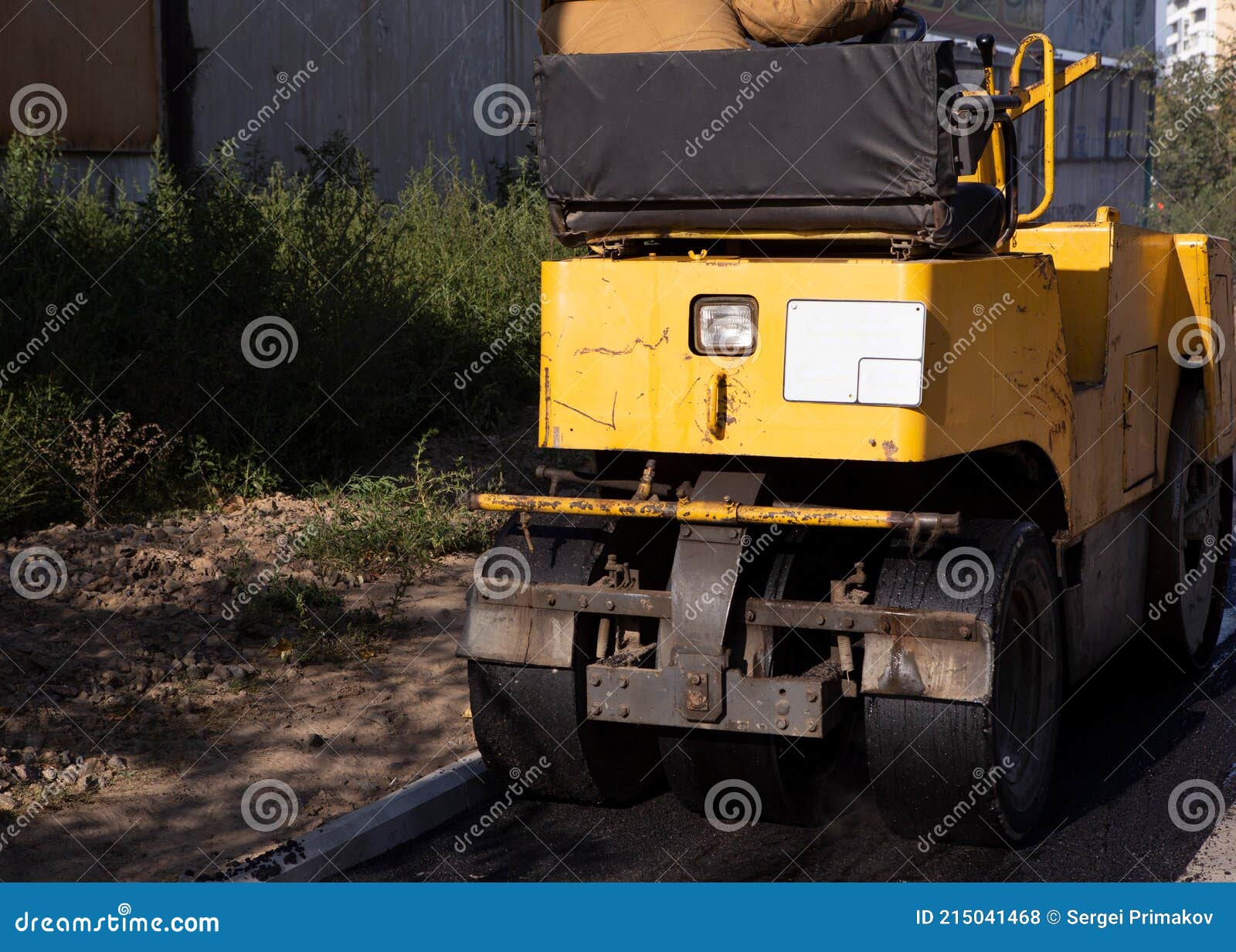 Steamroller Compacts Asphalt In Road Repaving Project. Royalty-Free ...