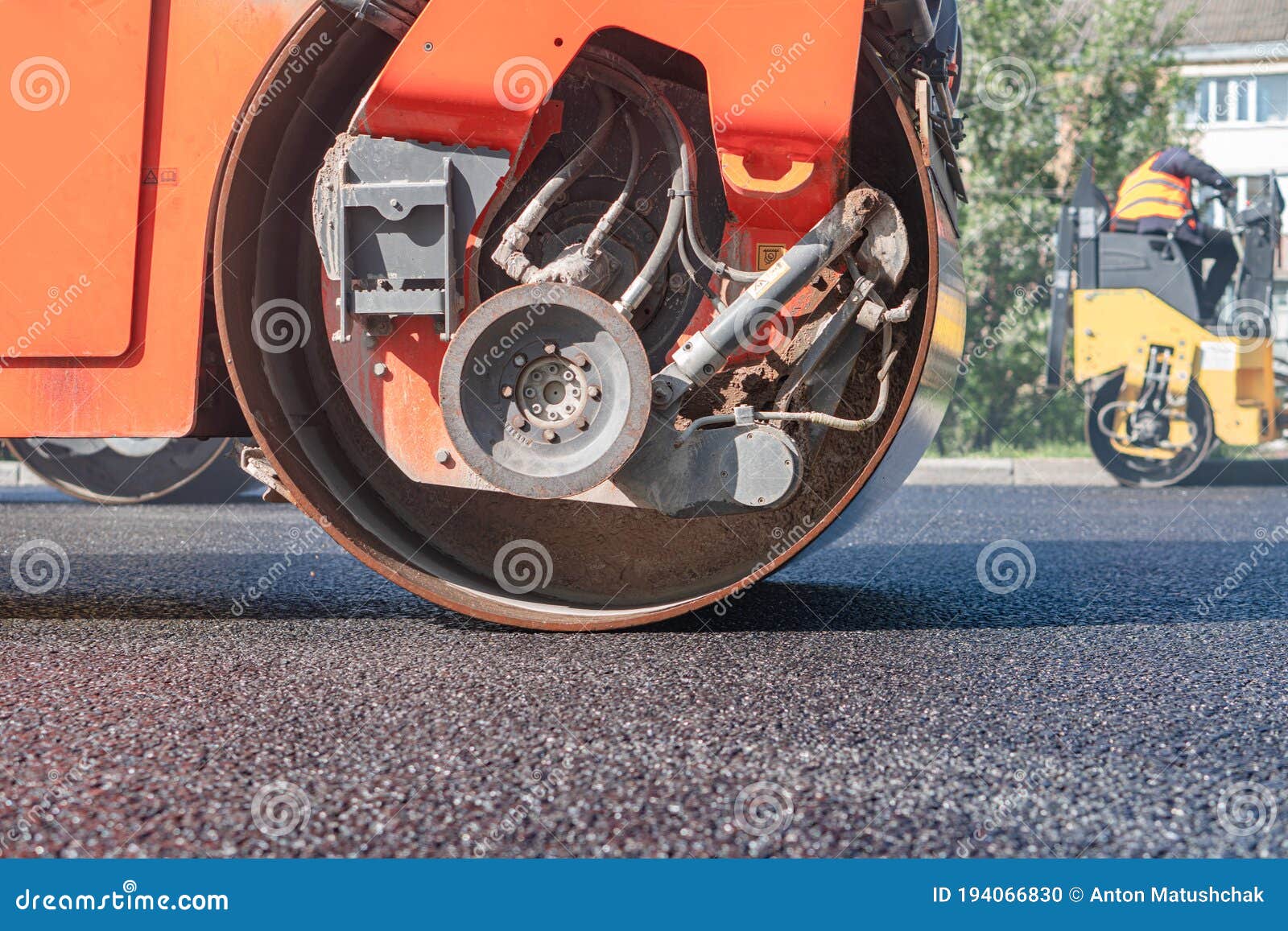 The Roller Flattens the Asphalt Tar, Paving the New Asphalt Stock Photo ...