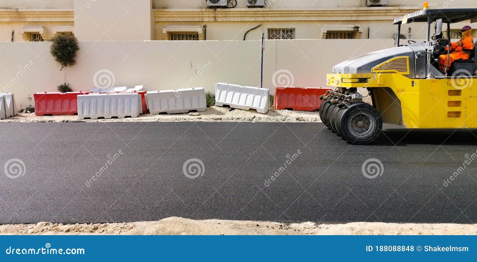 Roller Rolling Fresh Hot Asphalt on the New Road. Road Construction ...