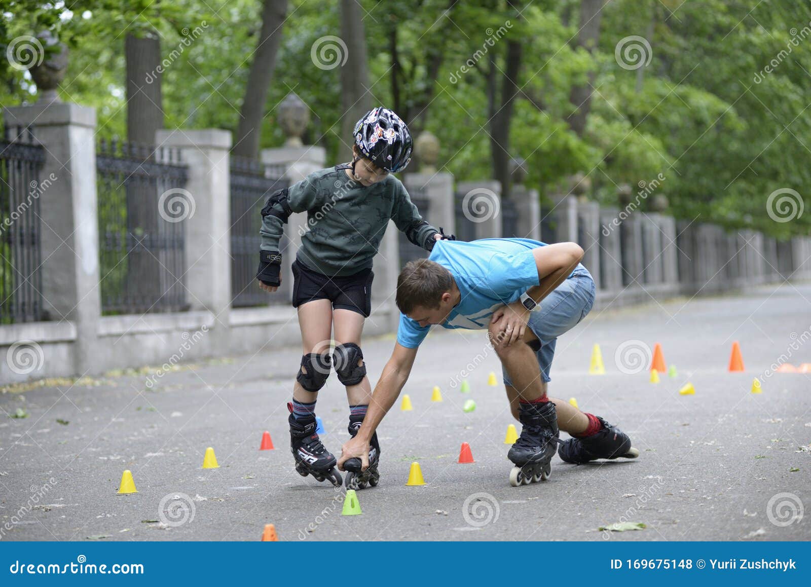 Rollerblading. Trainer Corrects Movements of Boyâ€™s Legs Teaching of ...