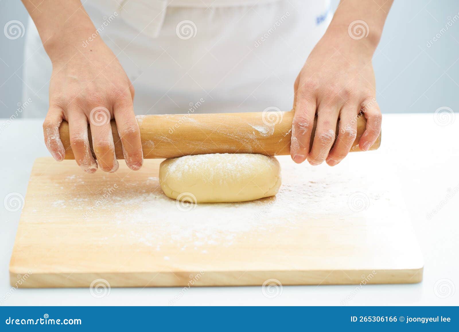 Rolling the Dough with a Rolling Pin, Bread Making Process Stock Photo ...