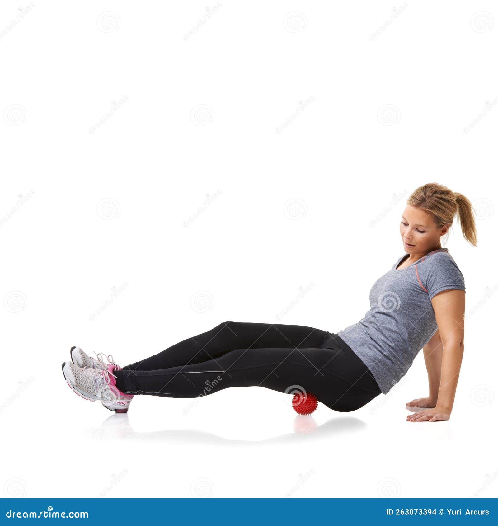 Rolling Out Her Glutes. a Young Woman Using an Exercise Ball To Work ...