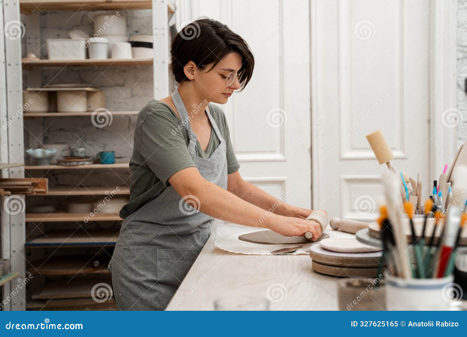 Rolling Wooden Stick To Make Flat Sheet of Clay. Preparing Clay for ...
