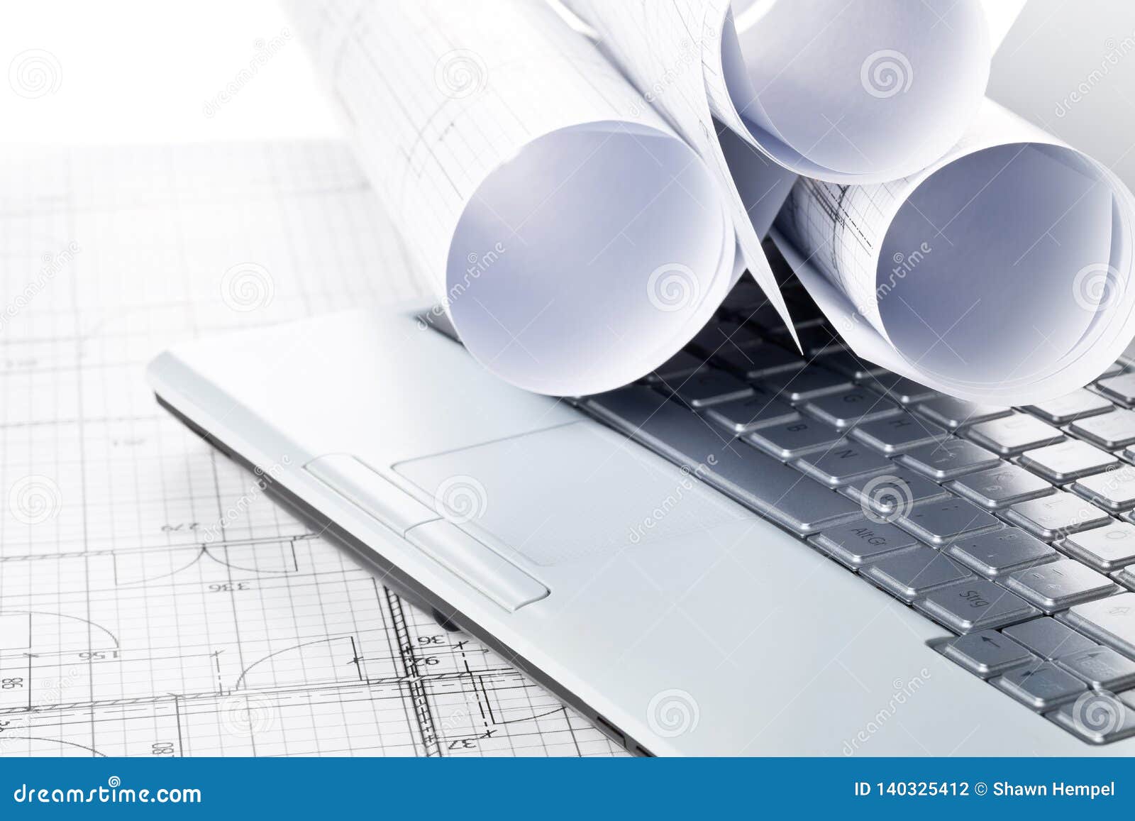 Rolls of Architectural Blueprint House Building Plans on Laptop ...