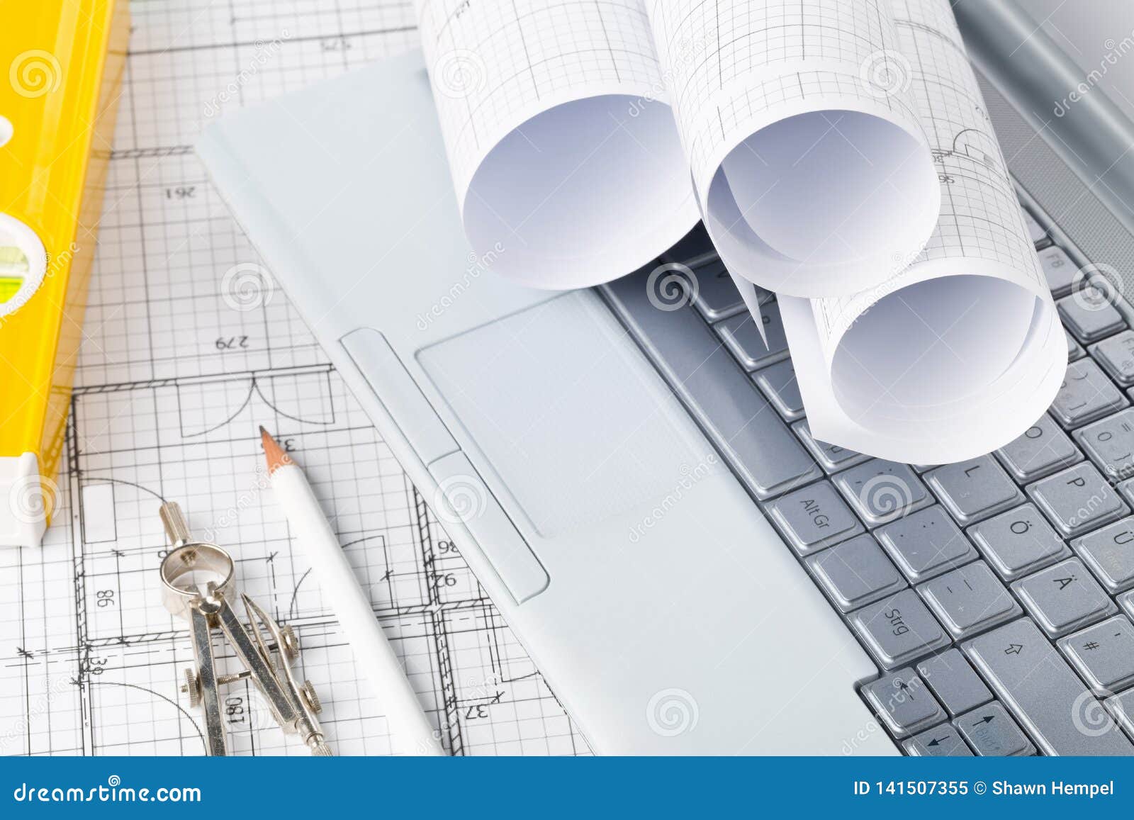 Rolls of Architectural Blueprint House Building Plans on Laptop ...
