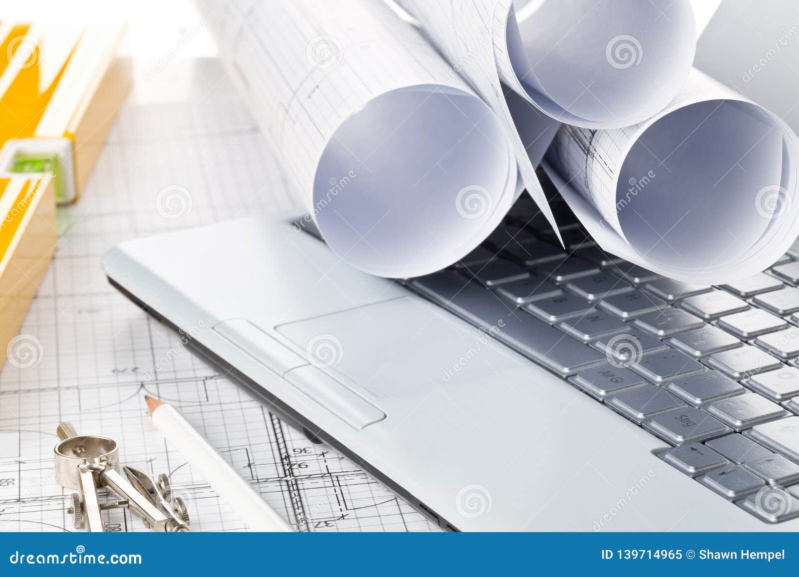 Rolls of Architectural Blueprint House Building Plans on Laptop ...