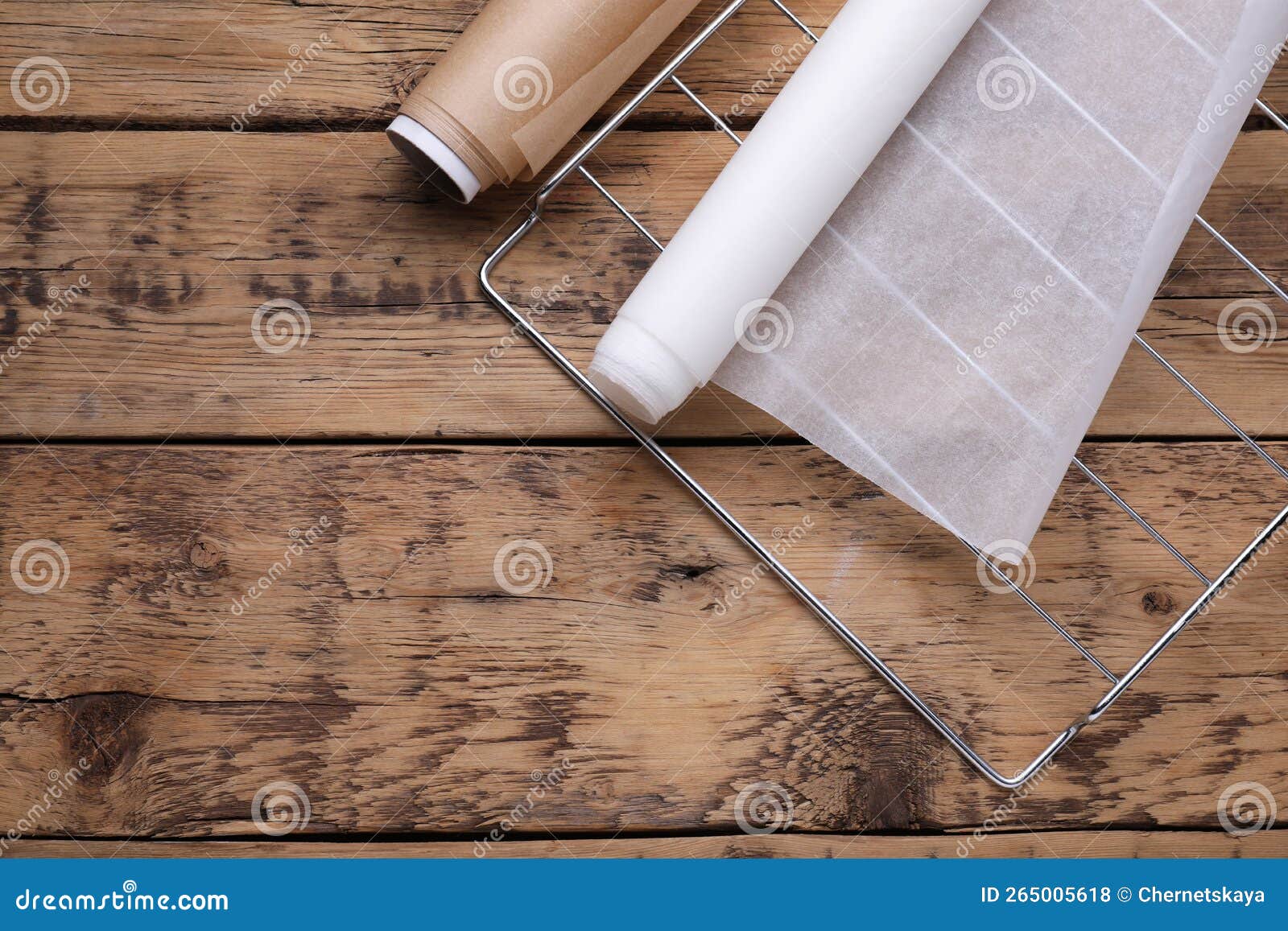 Rolls of Baking Parchment Paper and Cooling Rack on Wooden Table, Flat ...