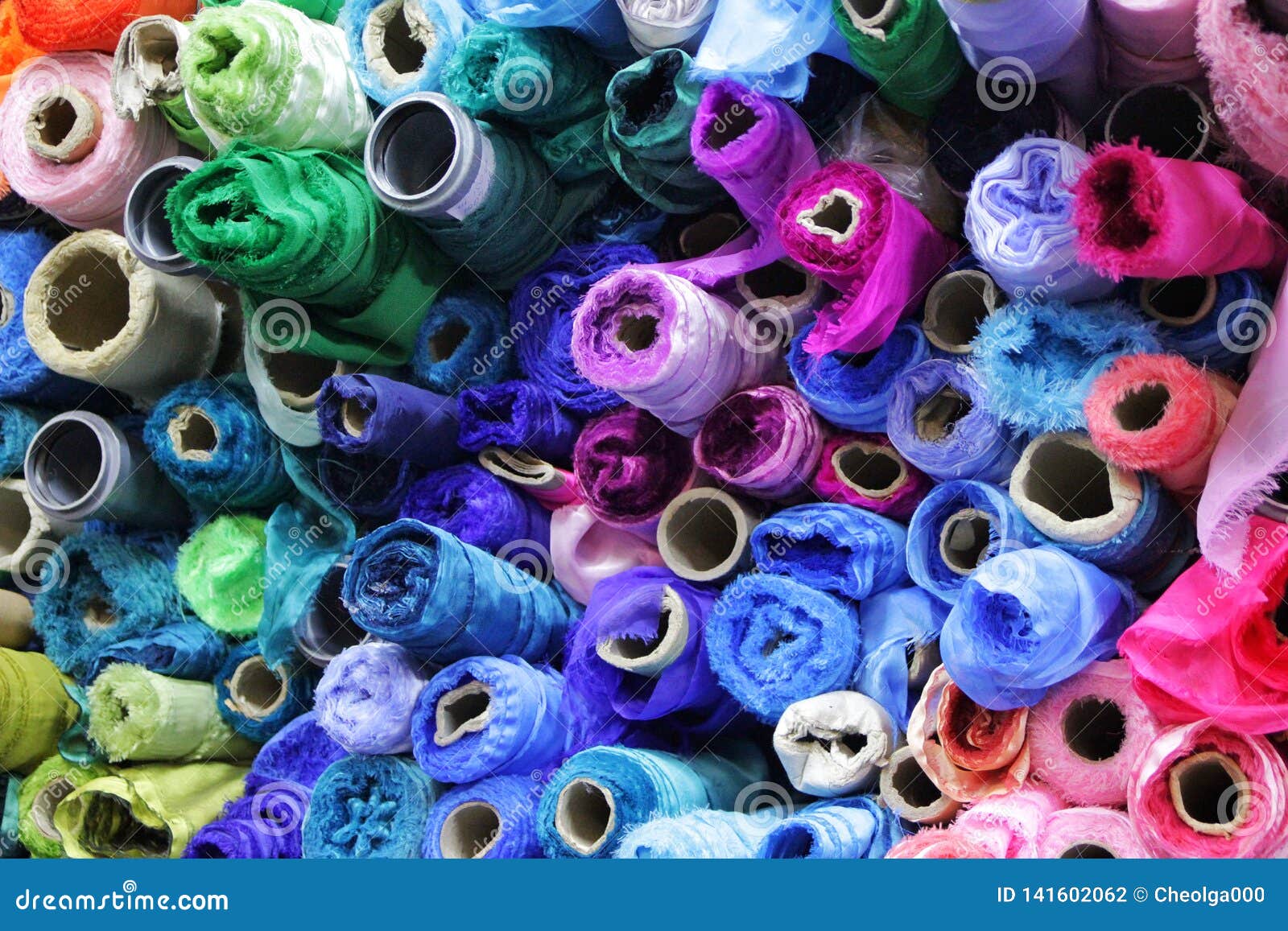 Rolls of colored fabrics stock photo. Image of bobbin - 141602062