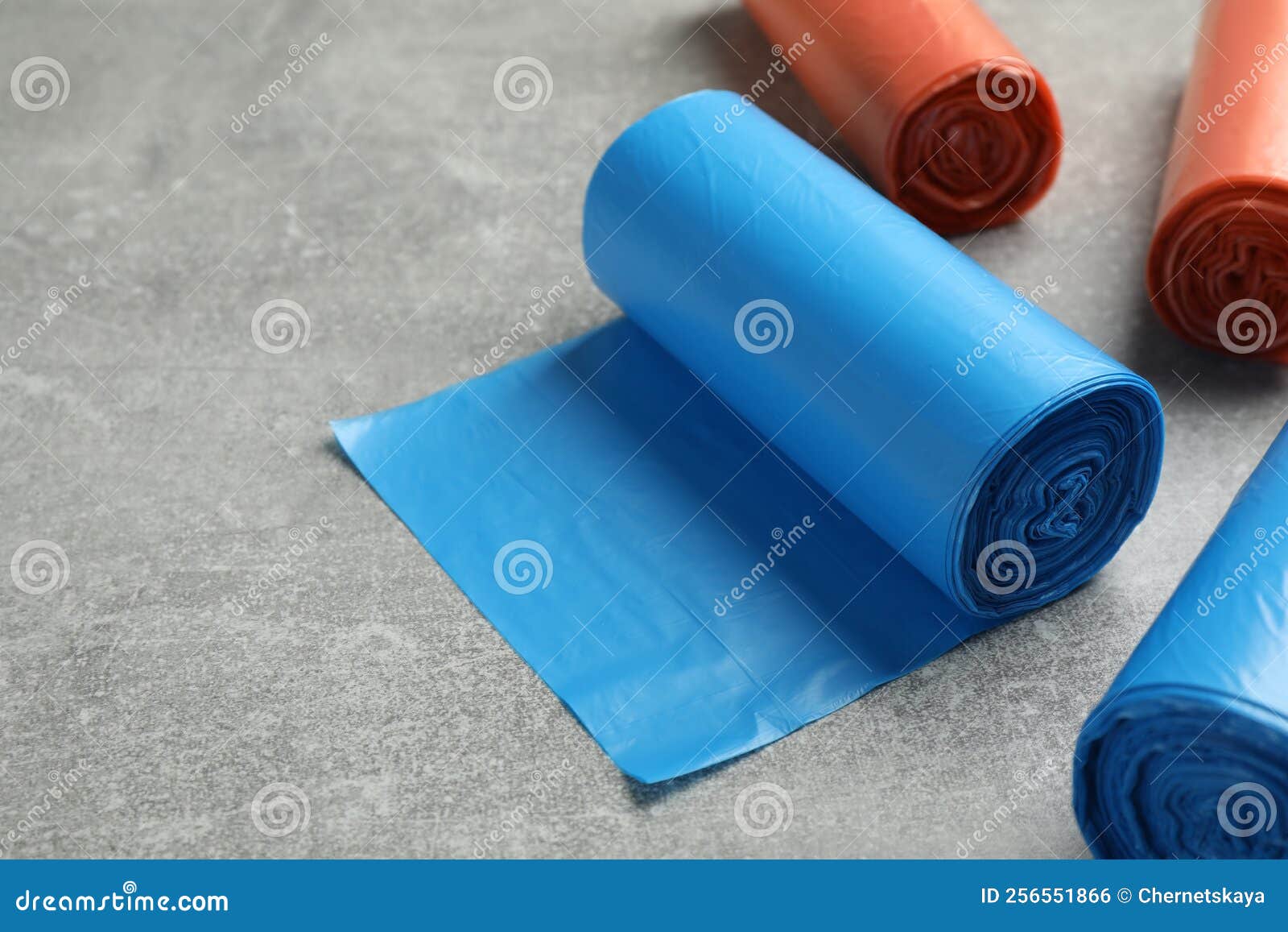 Rolls of Different Color Garbage Bags on Light Grey Stone Table Stock ...
