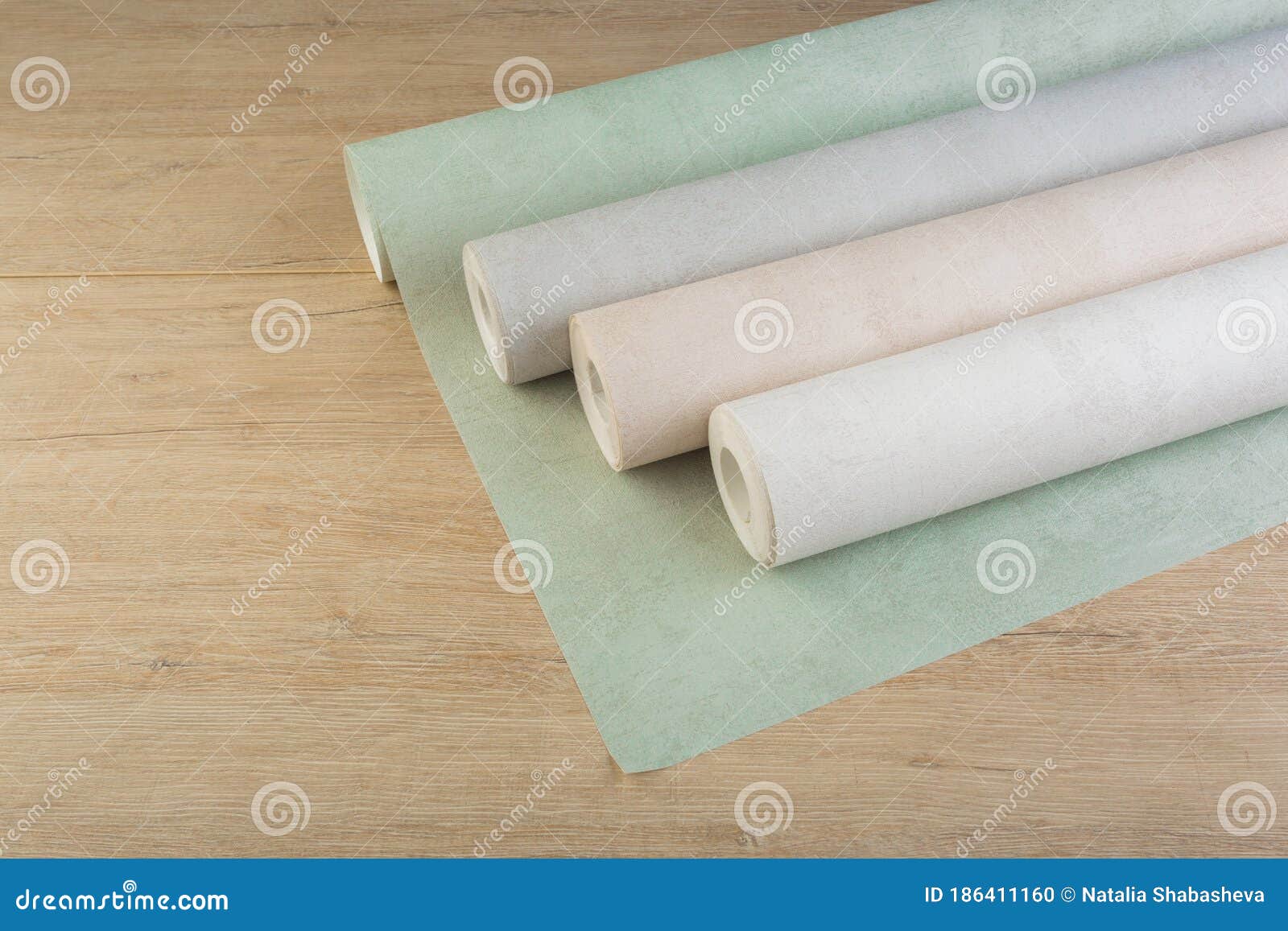 Rolls of Multi-colored Paper Wallpaper on a Wooden Table Stock Photo ...