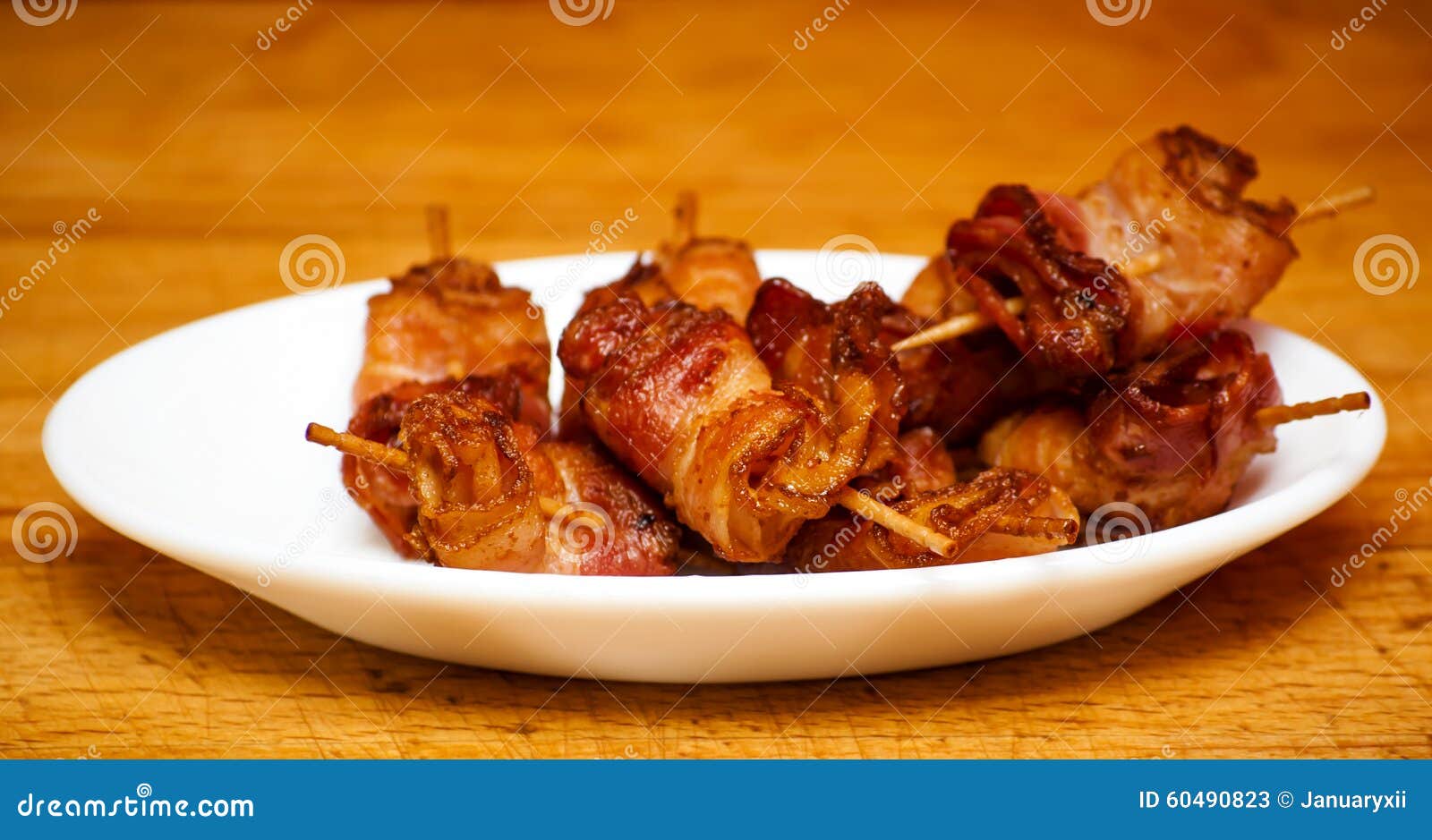 Rolls of Slices of Cooked Bacon Subject with a Toothpick on a Wh Stock ...