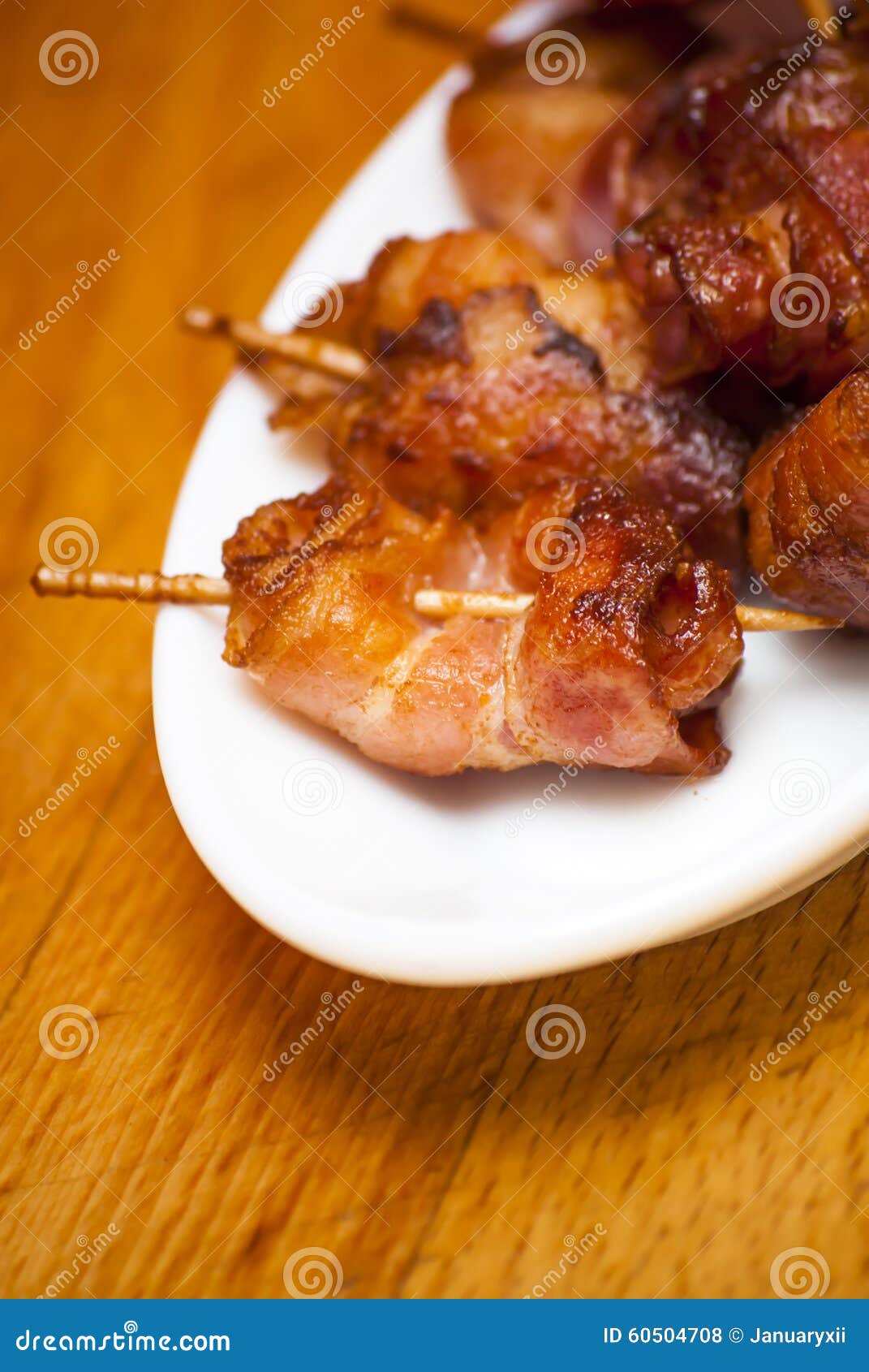 Rolls of Slices of Cooked Bacon Subject with a Toothpick on a Wh Stock ...