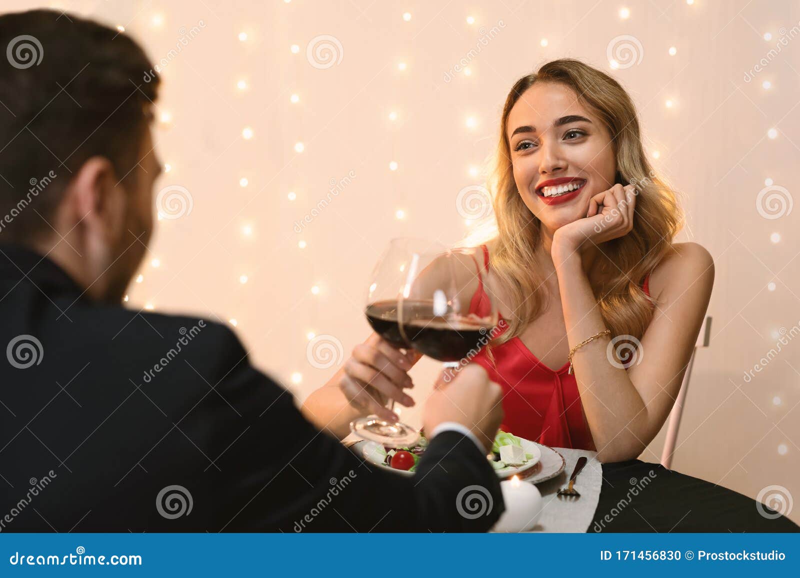 Romantic Couple Dining In Restaurant Drinking Wine And Enjoying