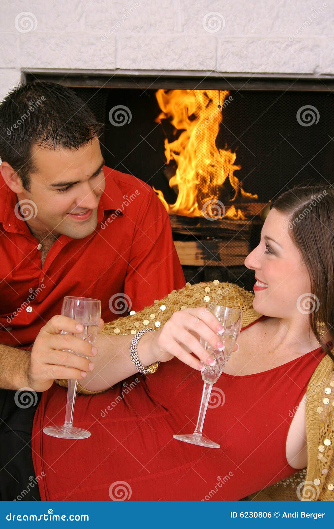 Romantic Couple by Fireplace Vertical Stock Photo - Image of date ...