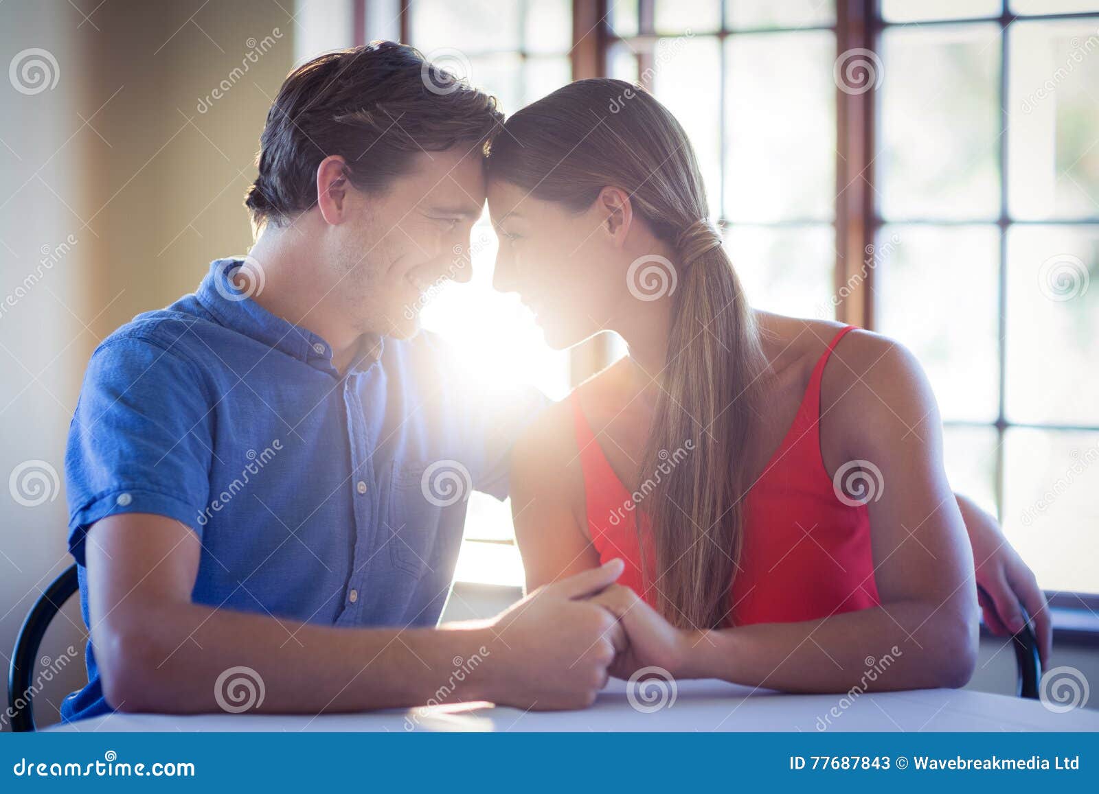 Romantic Couple Holding Hands and Sitting Face To Face Stock Image ...