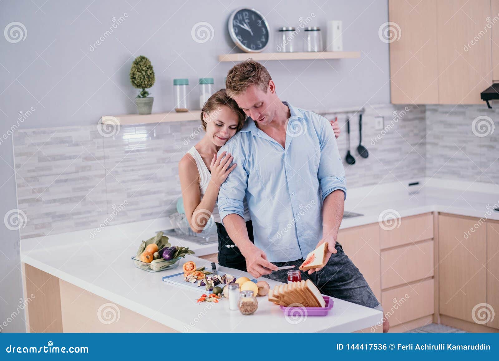 Romantic Couple Hugging and Smiling while Make Breakfast Stock Photo ...